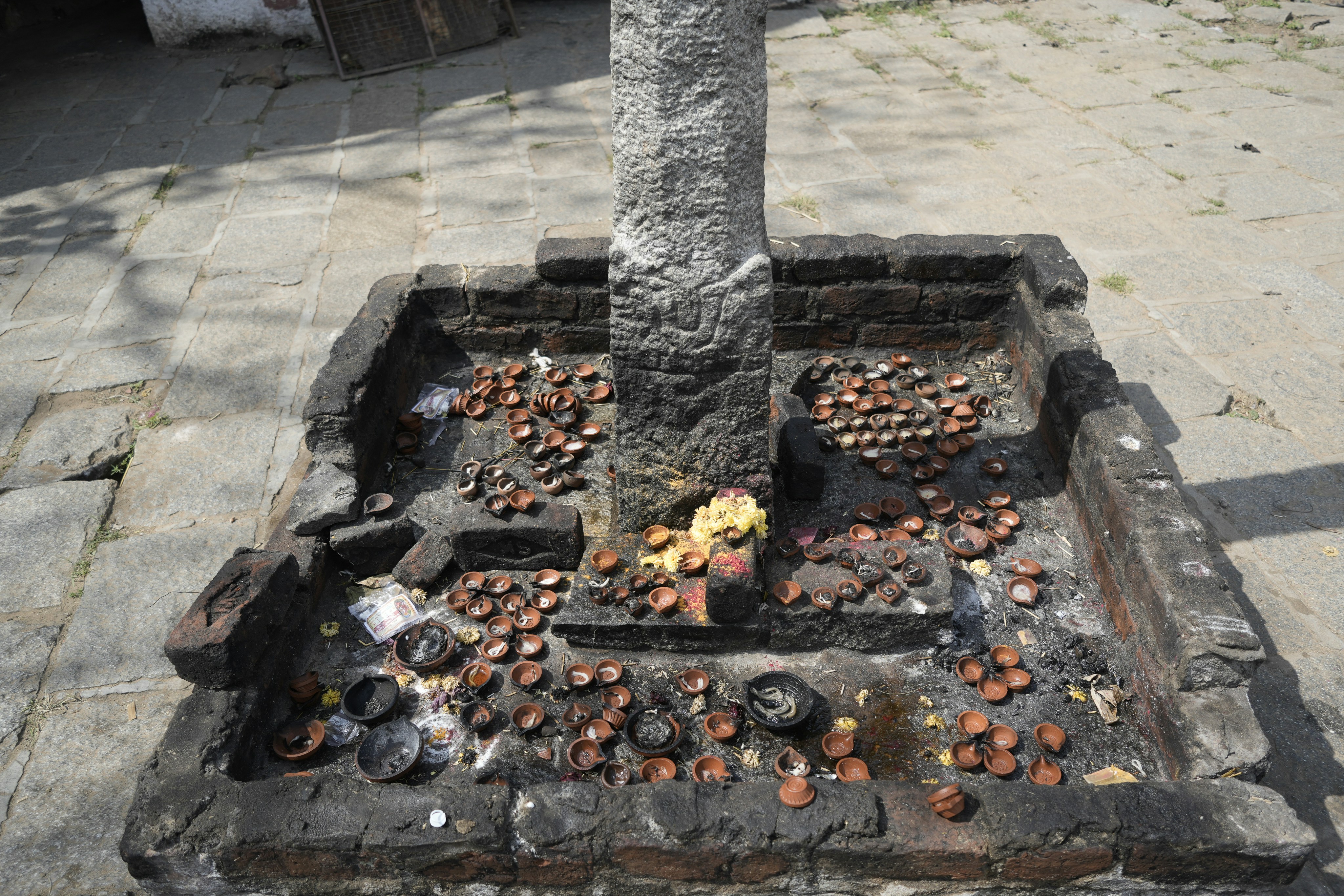 Coins at the Pedestal: A Weathered Plaza’s Quiet Shrine