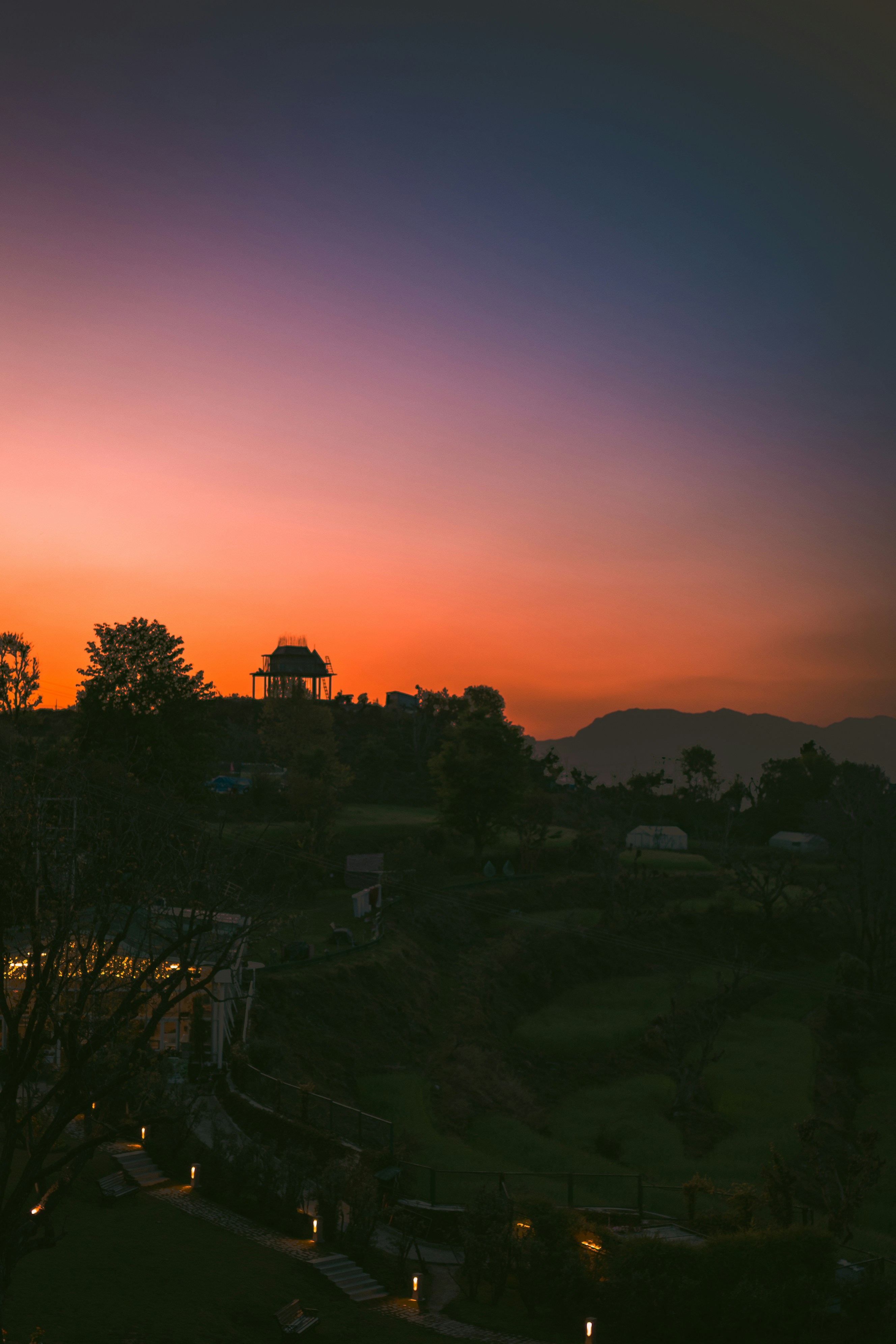 Horizon at Dusk: Silhouette of a hilltop with a watchtower