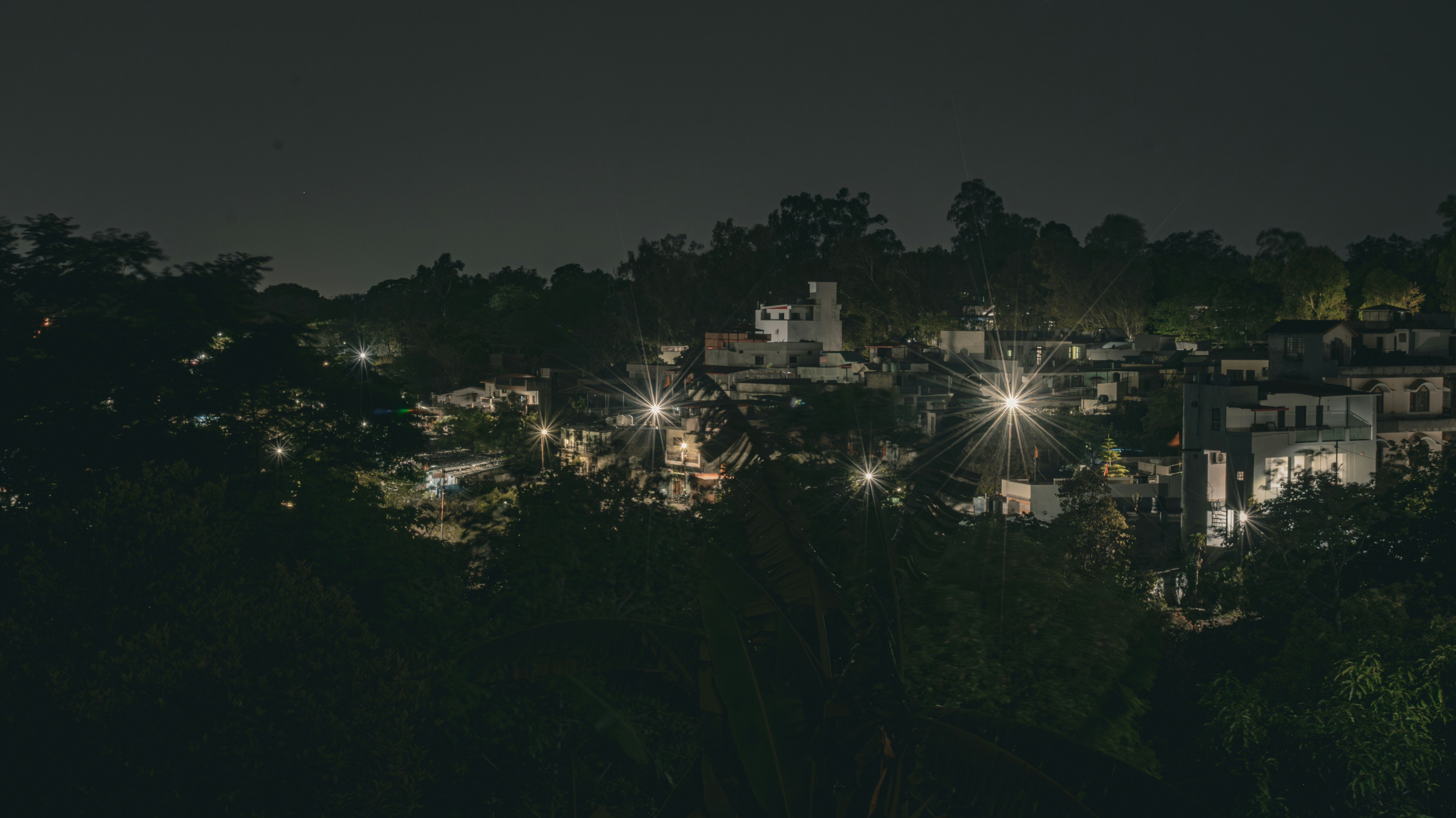 Nightfall in a Quiet Hill Town: Street Lights Bloom Over Rooftops
