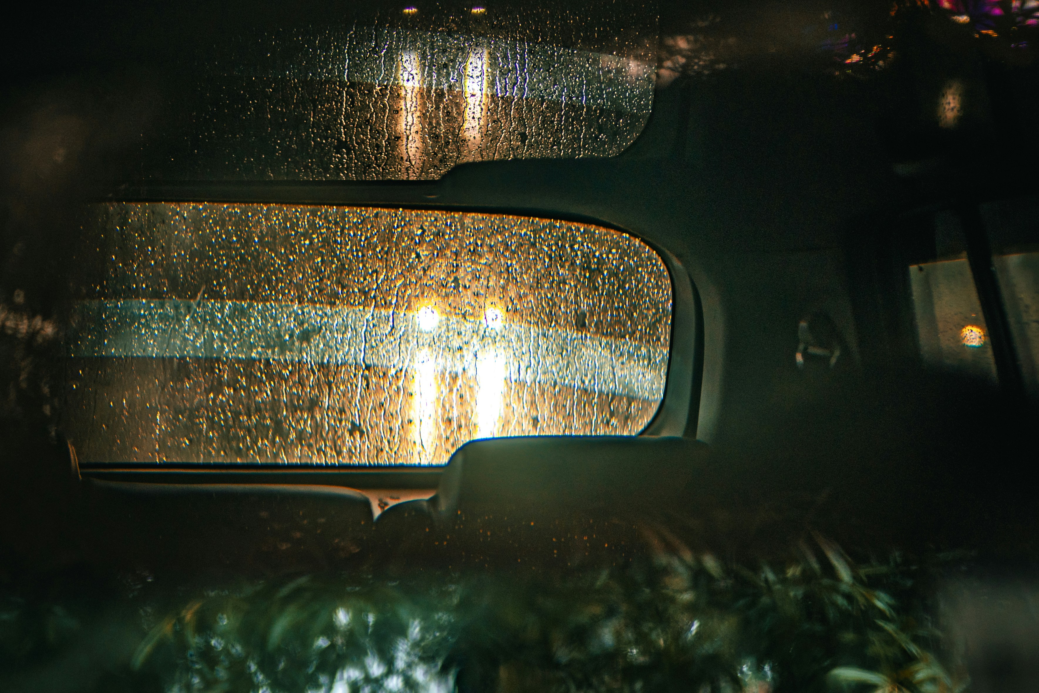 Rear Window Rain: Neon Reflections on a Night Ride
