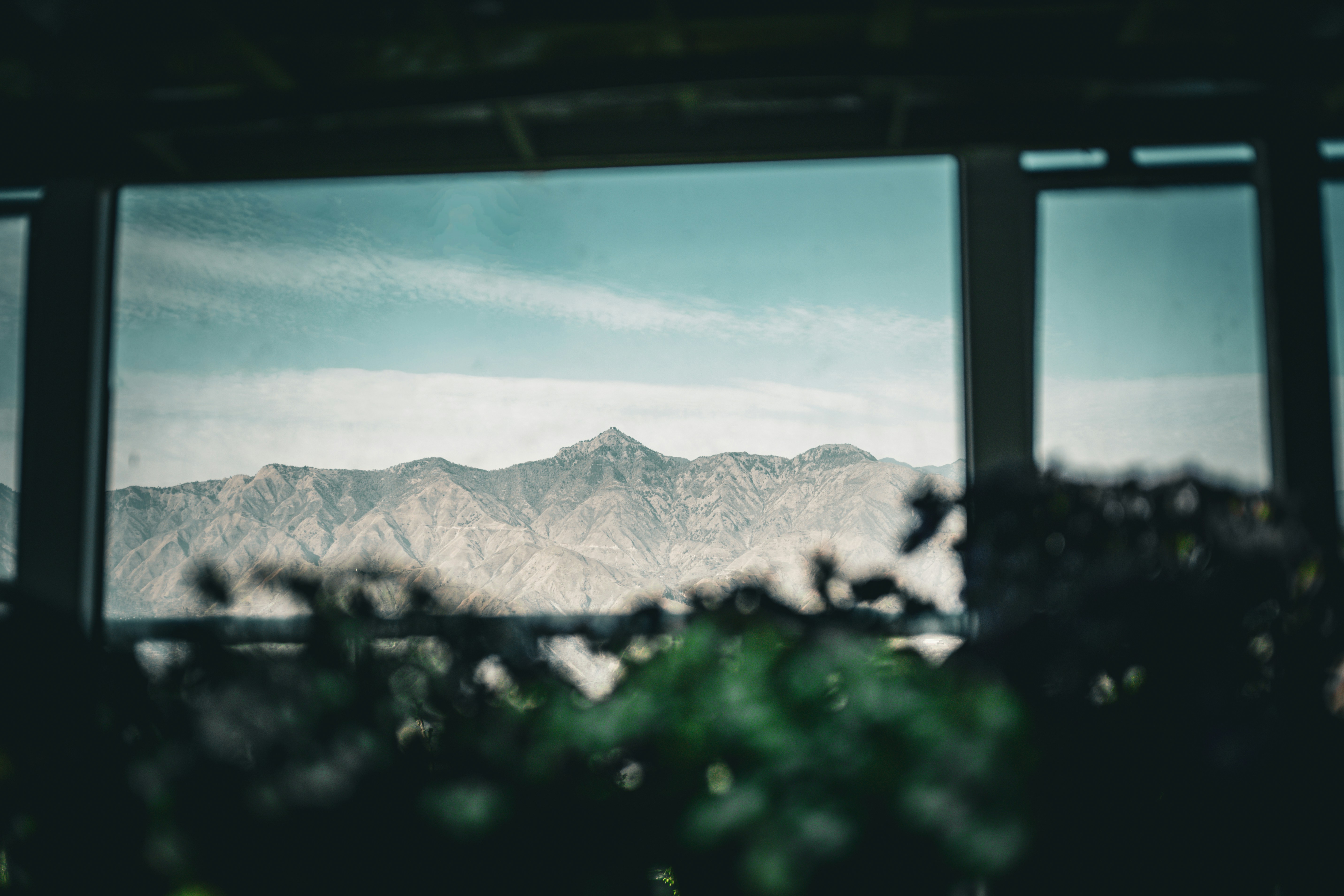 Window to the Range: Desert Peaks Framed by Interior Silhouettes
