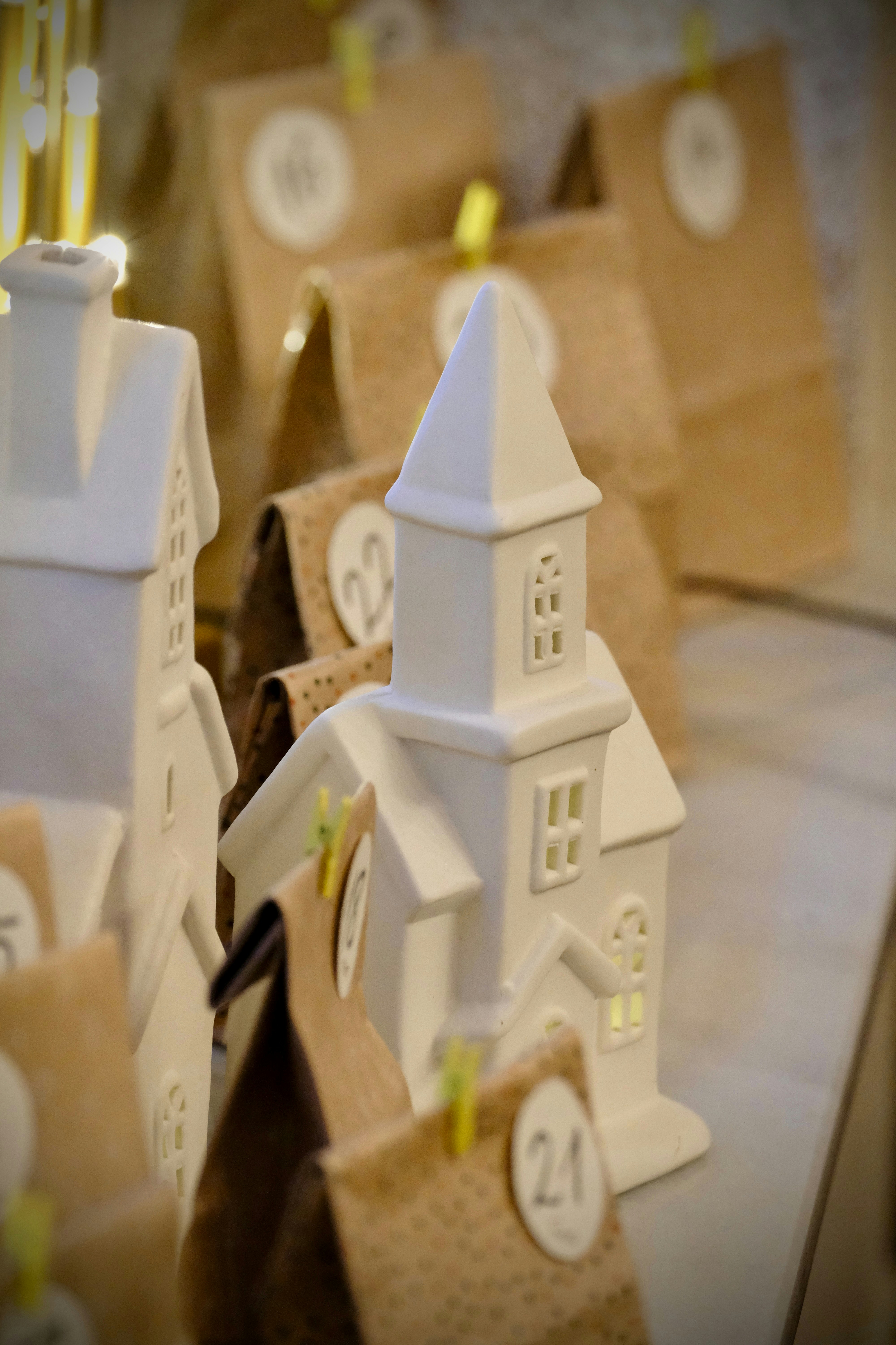 Soft-lit Christmas Village: White Steeples Surrounded by Gift Bags