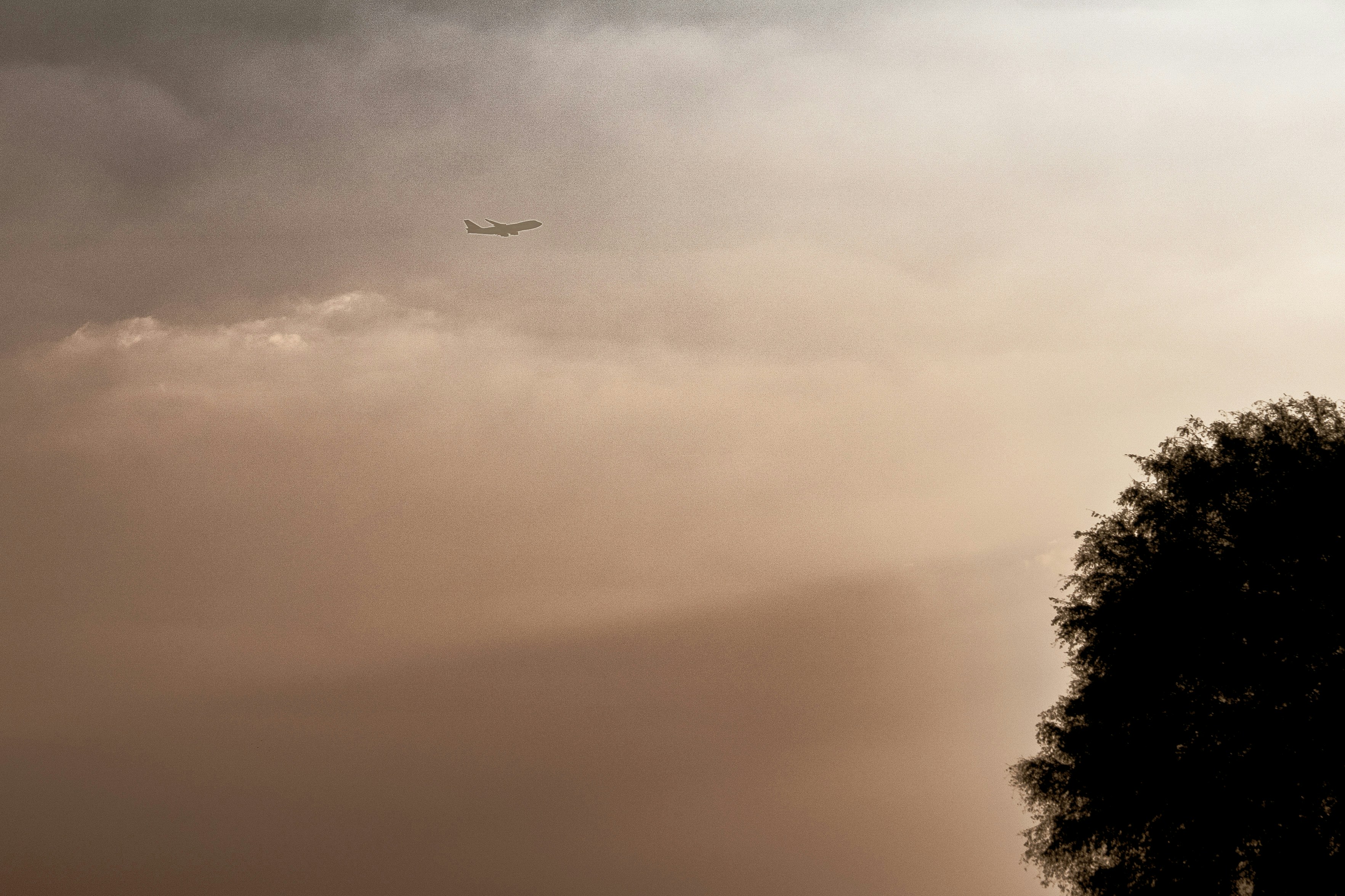 Airliner Silhouette Over a Quiet, Sunset Sky