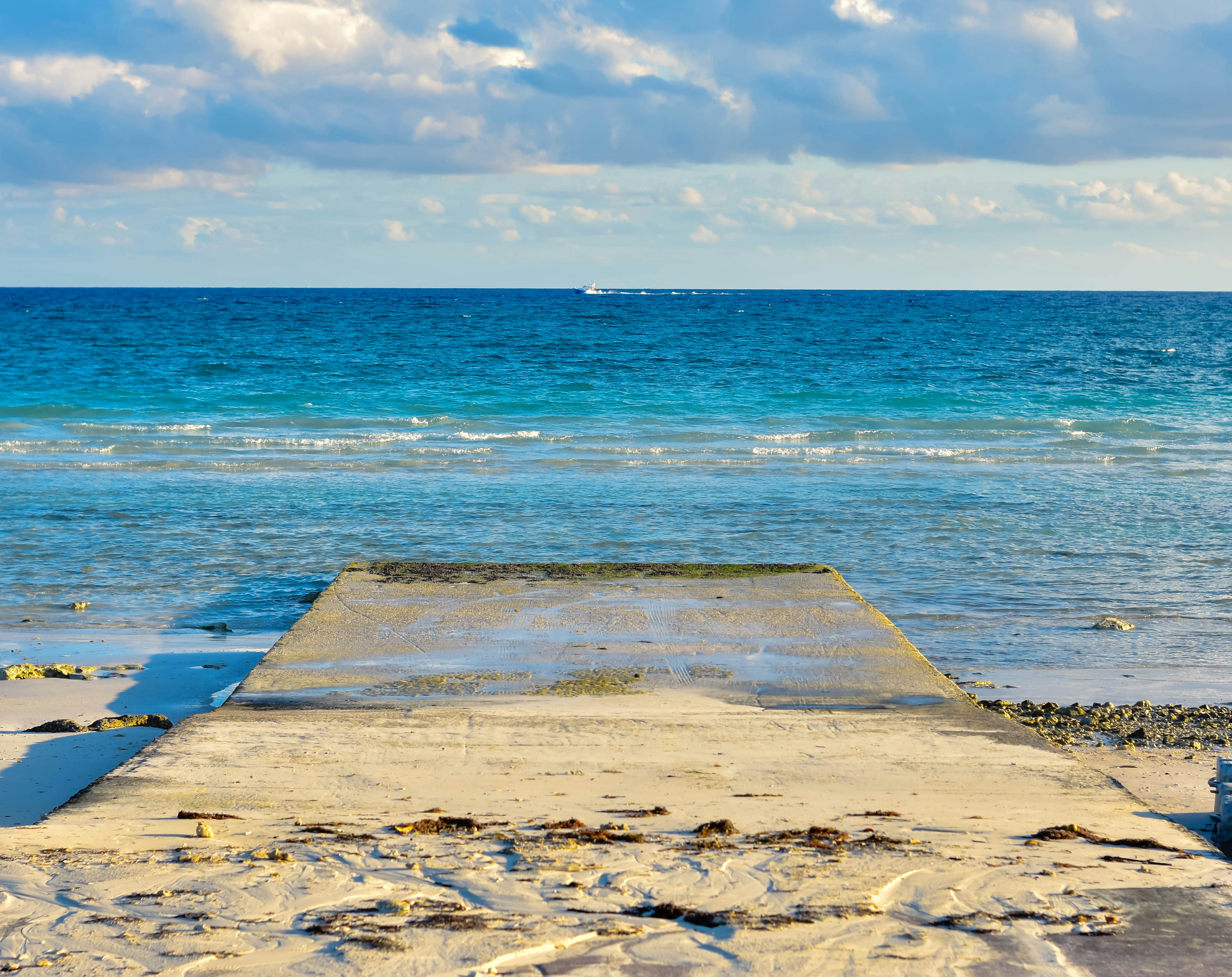Pier to Sea: A Quiet Confluence of Sand, Shadow, and Horizon
