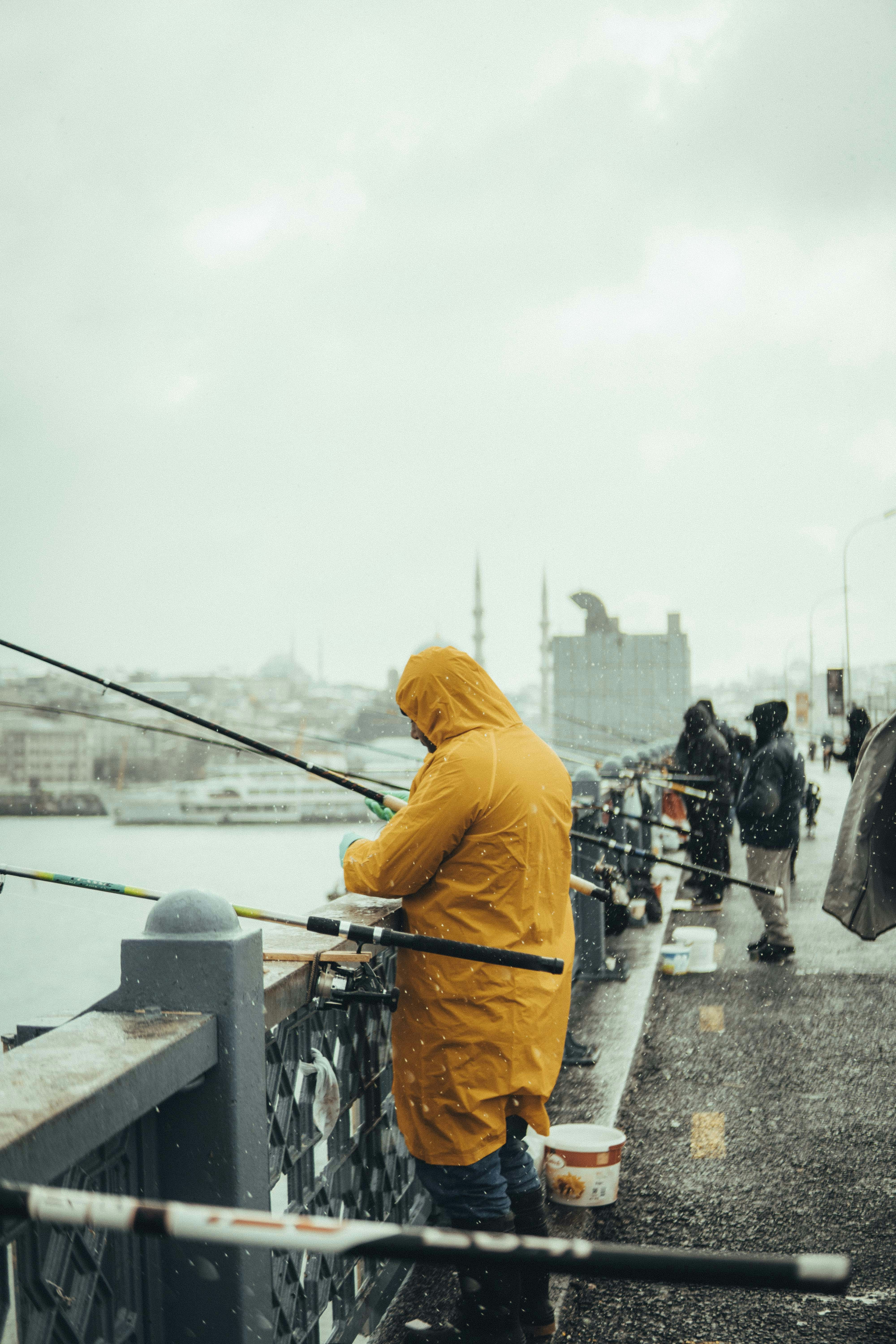 Orange Jacket, Quiet Vigil: Angler at the Riverside Ring