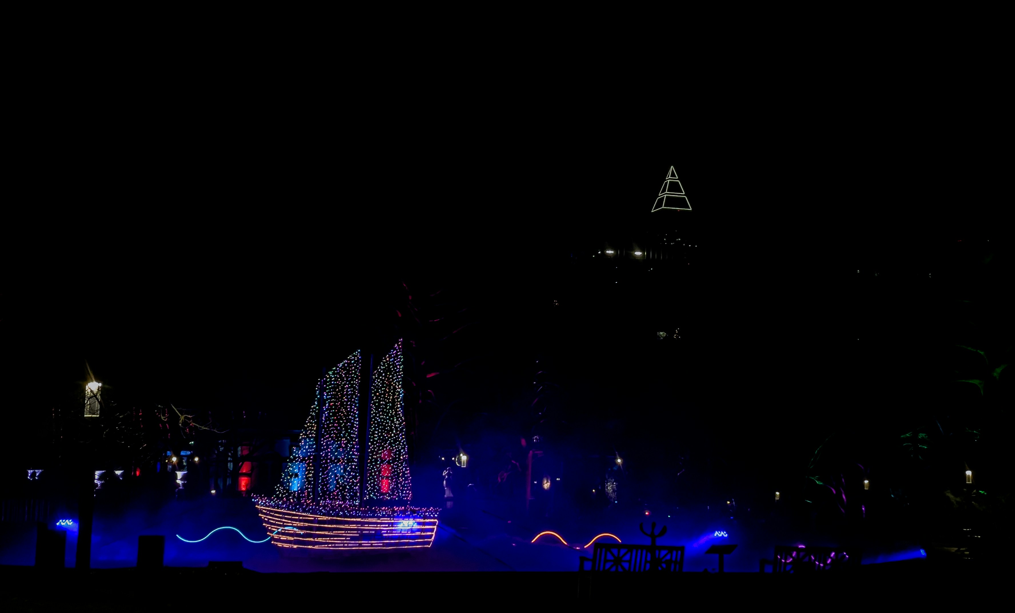 Glowing Sailboats on a Subdued Night Wharf