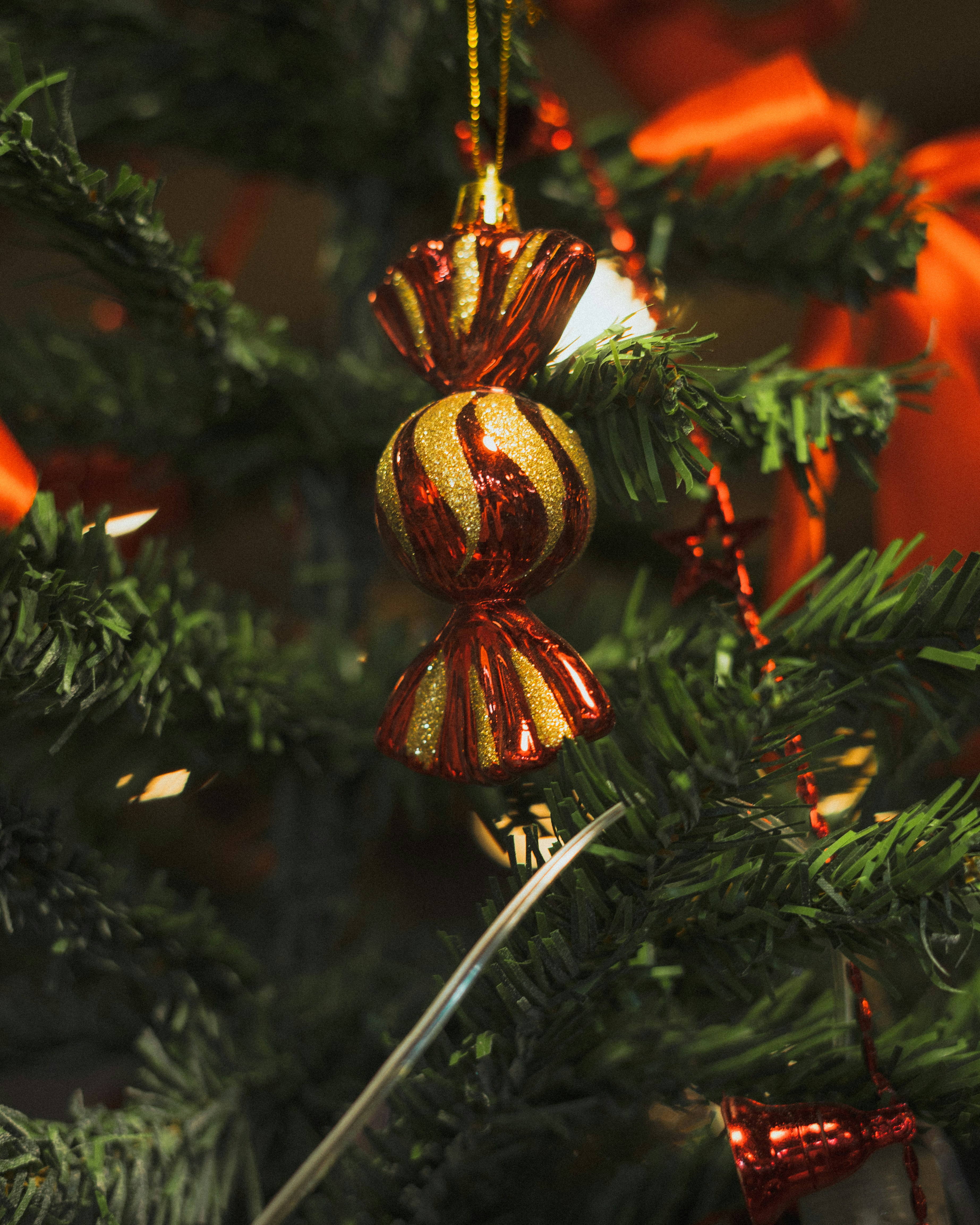 Glittering Candy-Stripe Ornament on a Lush Christmas Tree