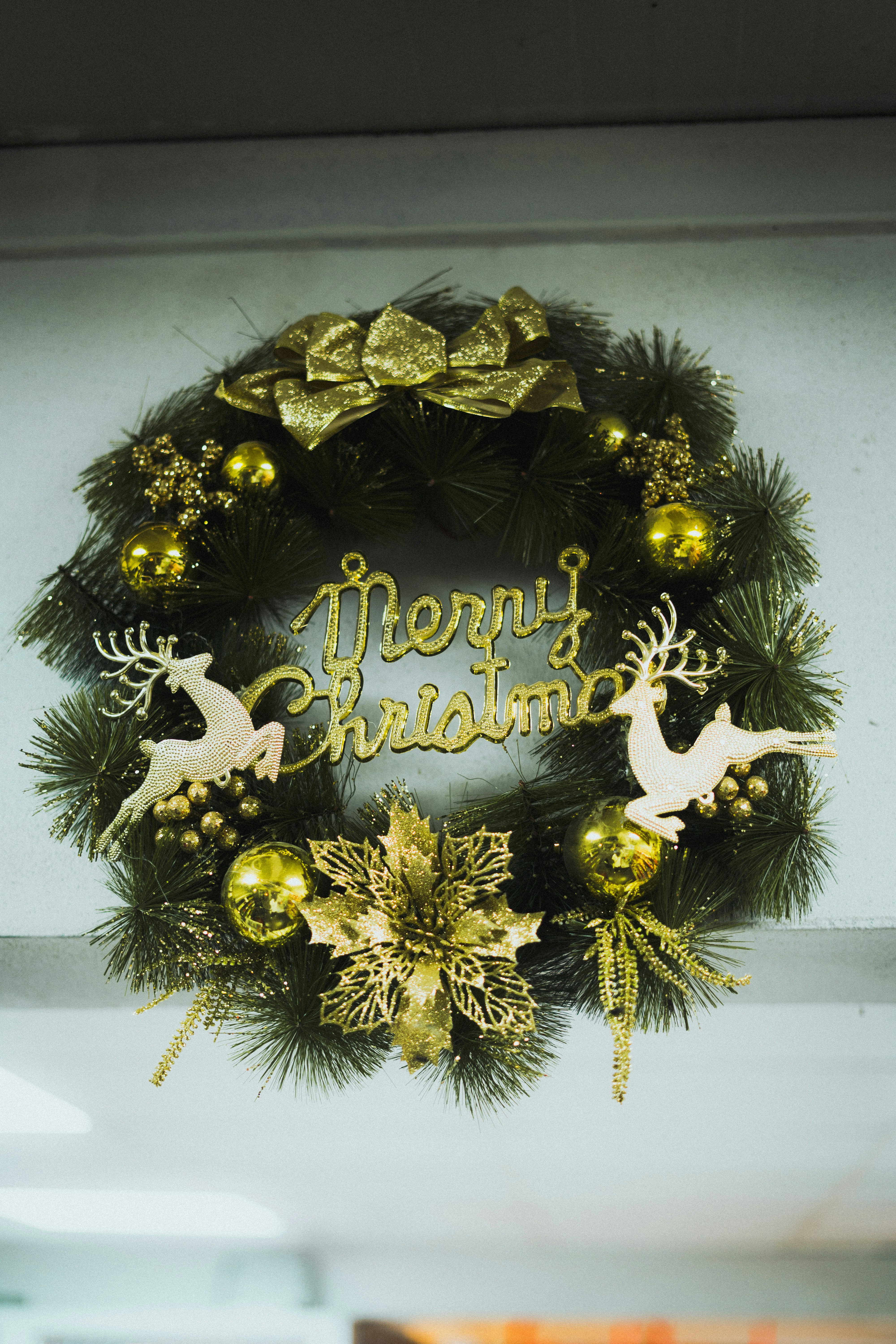 Golden Christmas Wreath: A festive centerpiece of sparkle and reindeer silhouettes