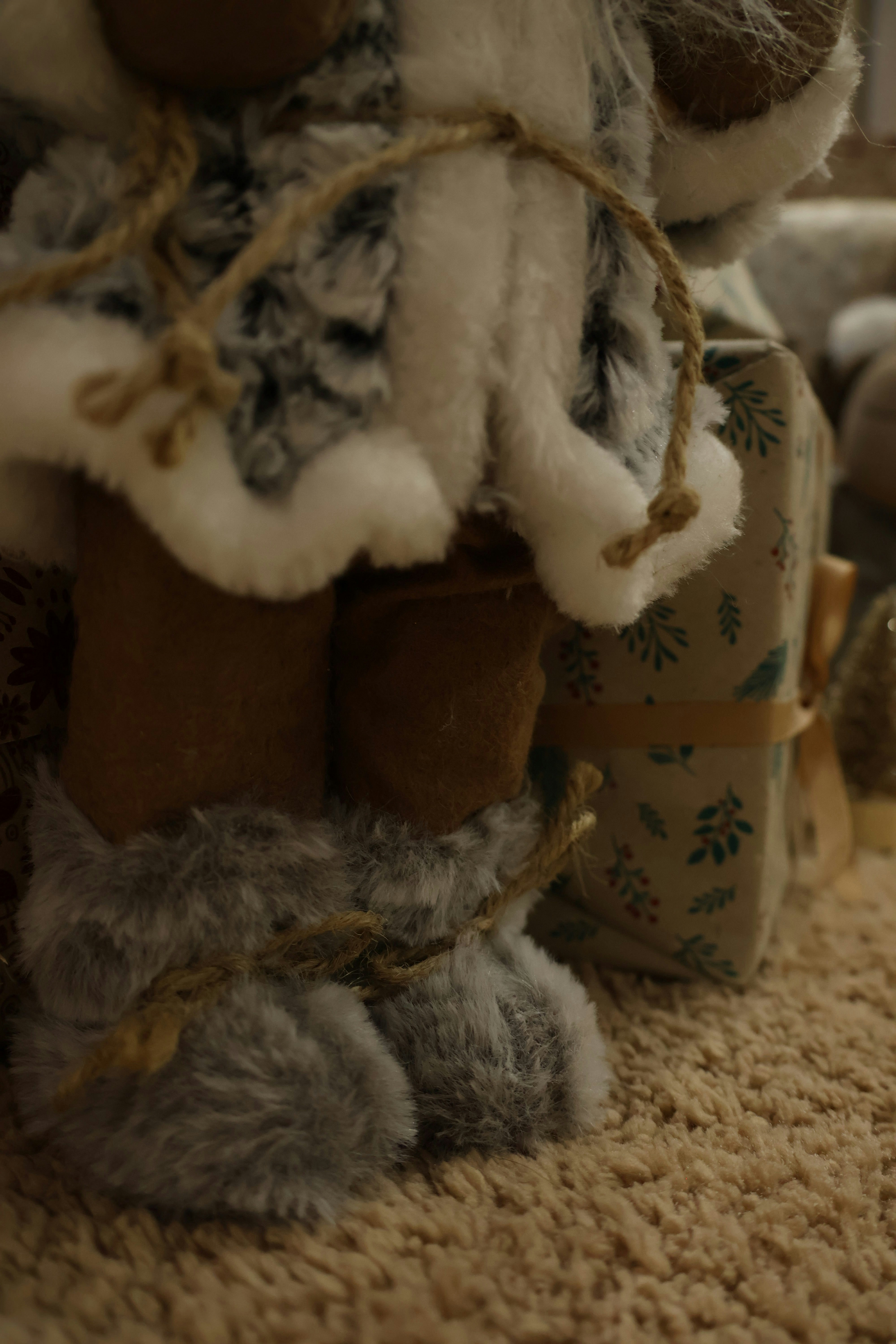 Winter Keepsake: Plush Boots and Gift Wrap in Warm Sepia Tones