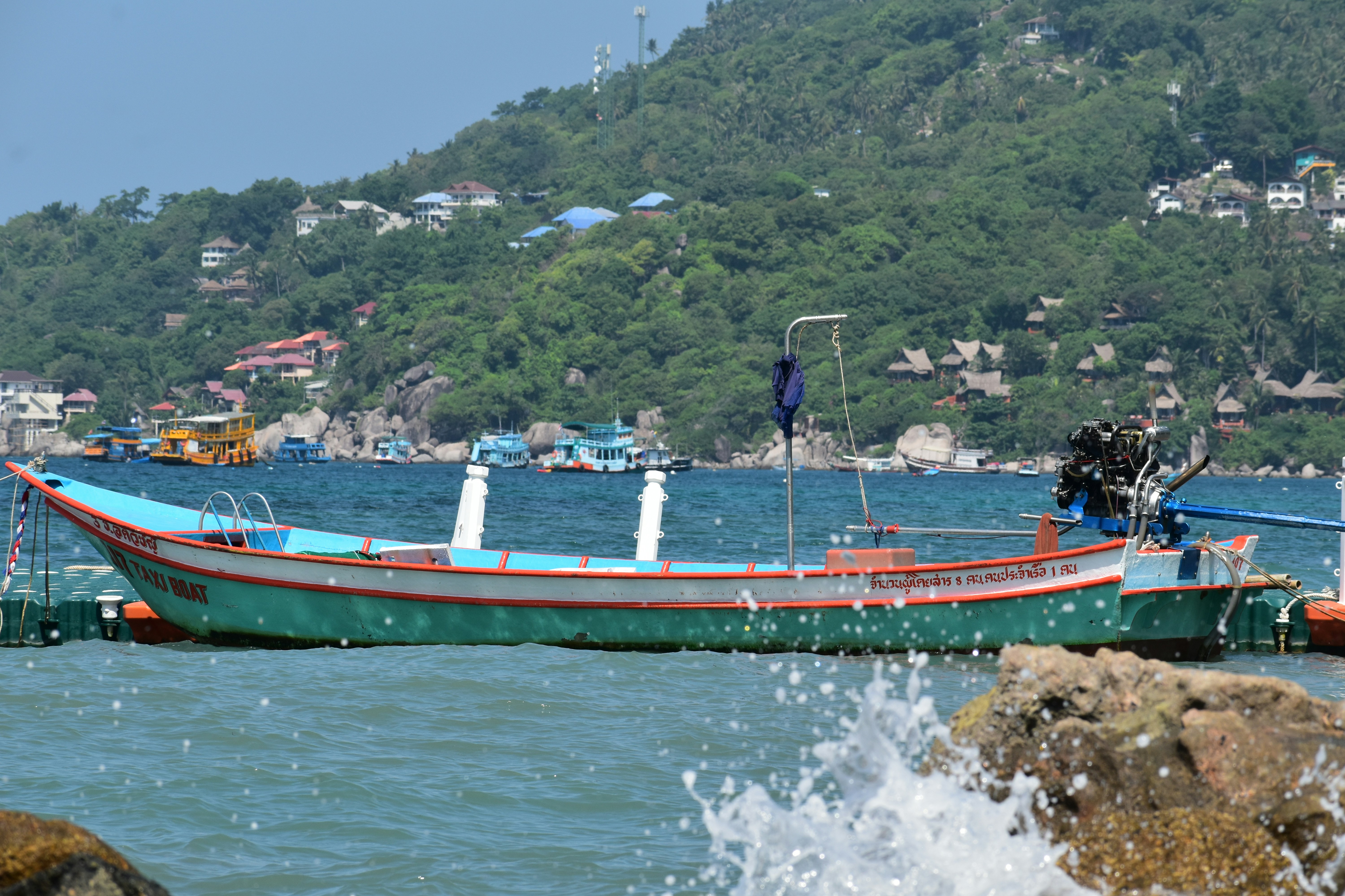Coastal Workboat Quietly Rests Against the Sea-Mashed Rocks