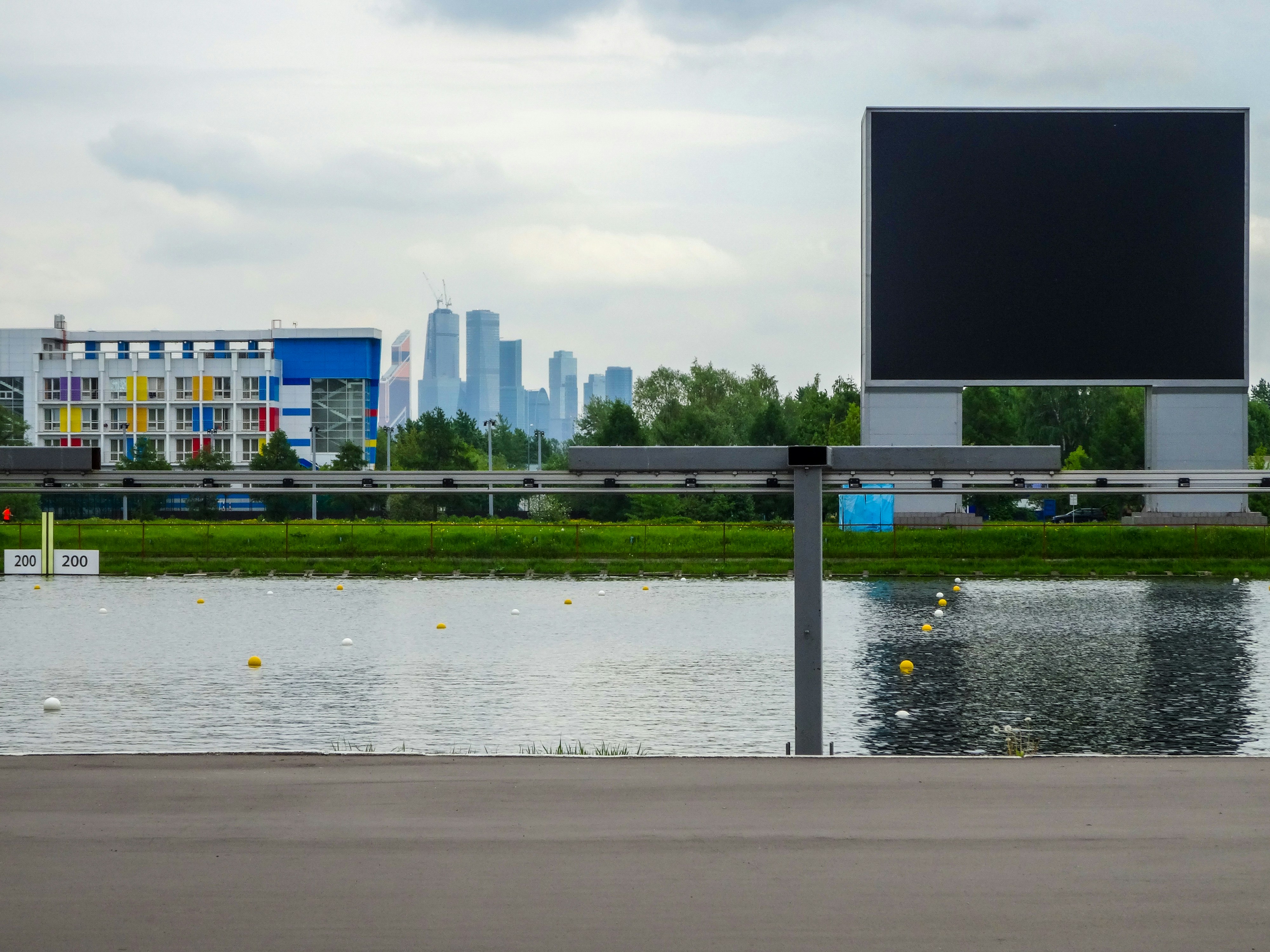 Billboard at the Waterfront: City Skyline Beyond the Quiet Promenade