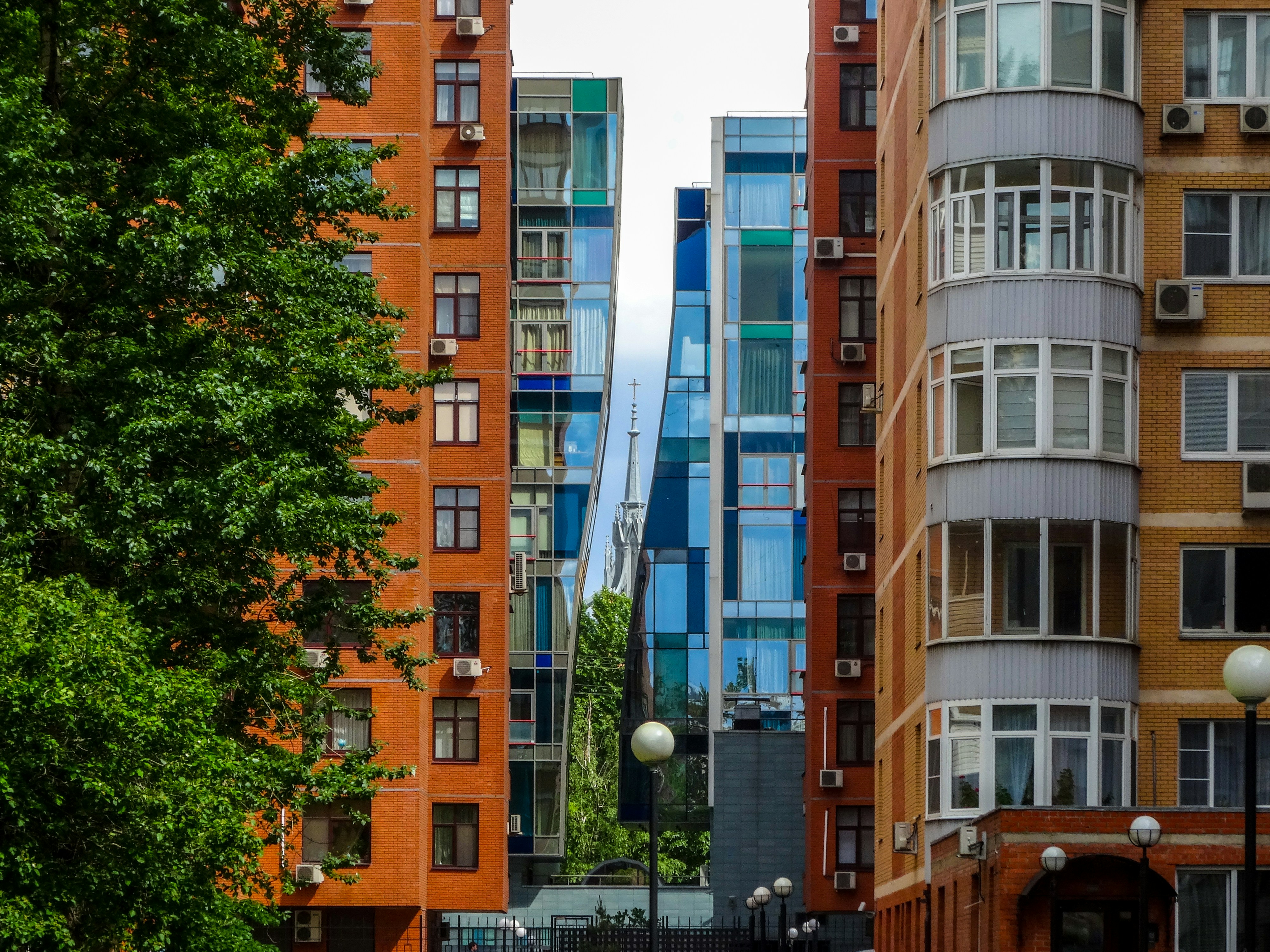 Central Glass Corridor Between Brick Towers