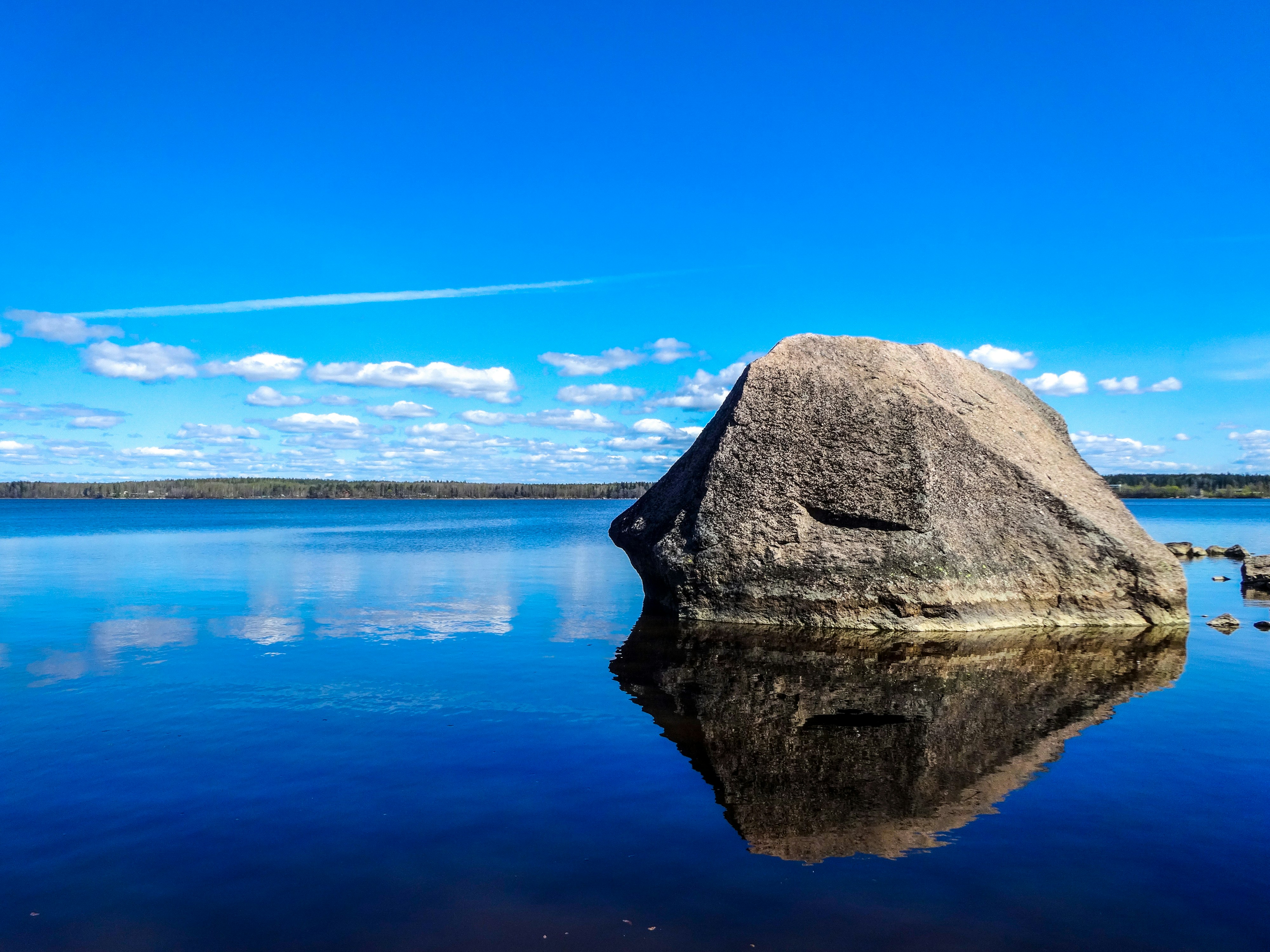 Solitary Boulder Poised Above a Mirror Lake