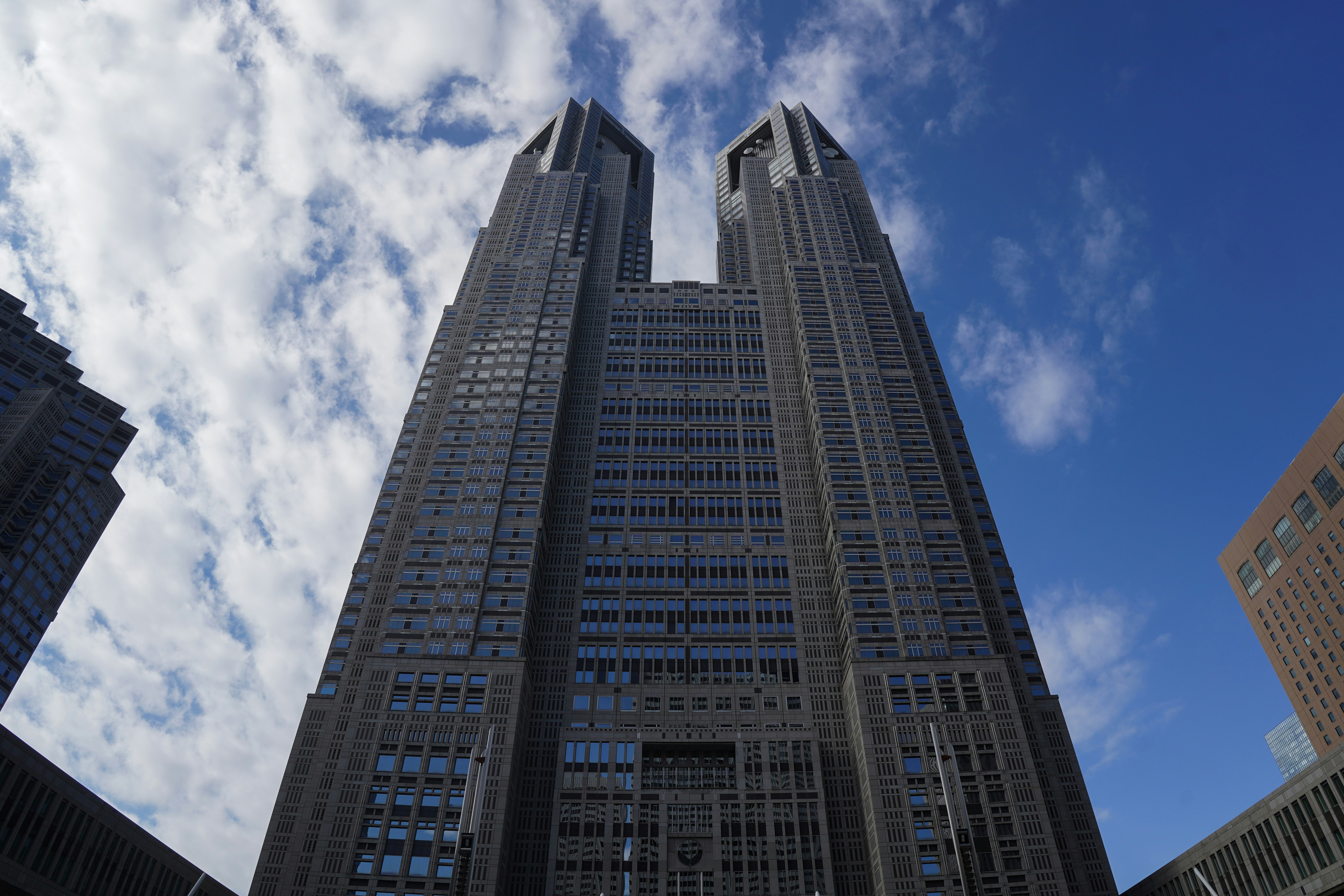 Twin-towered ascent: a towering city monument under a bright sky