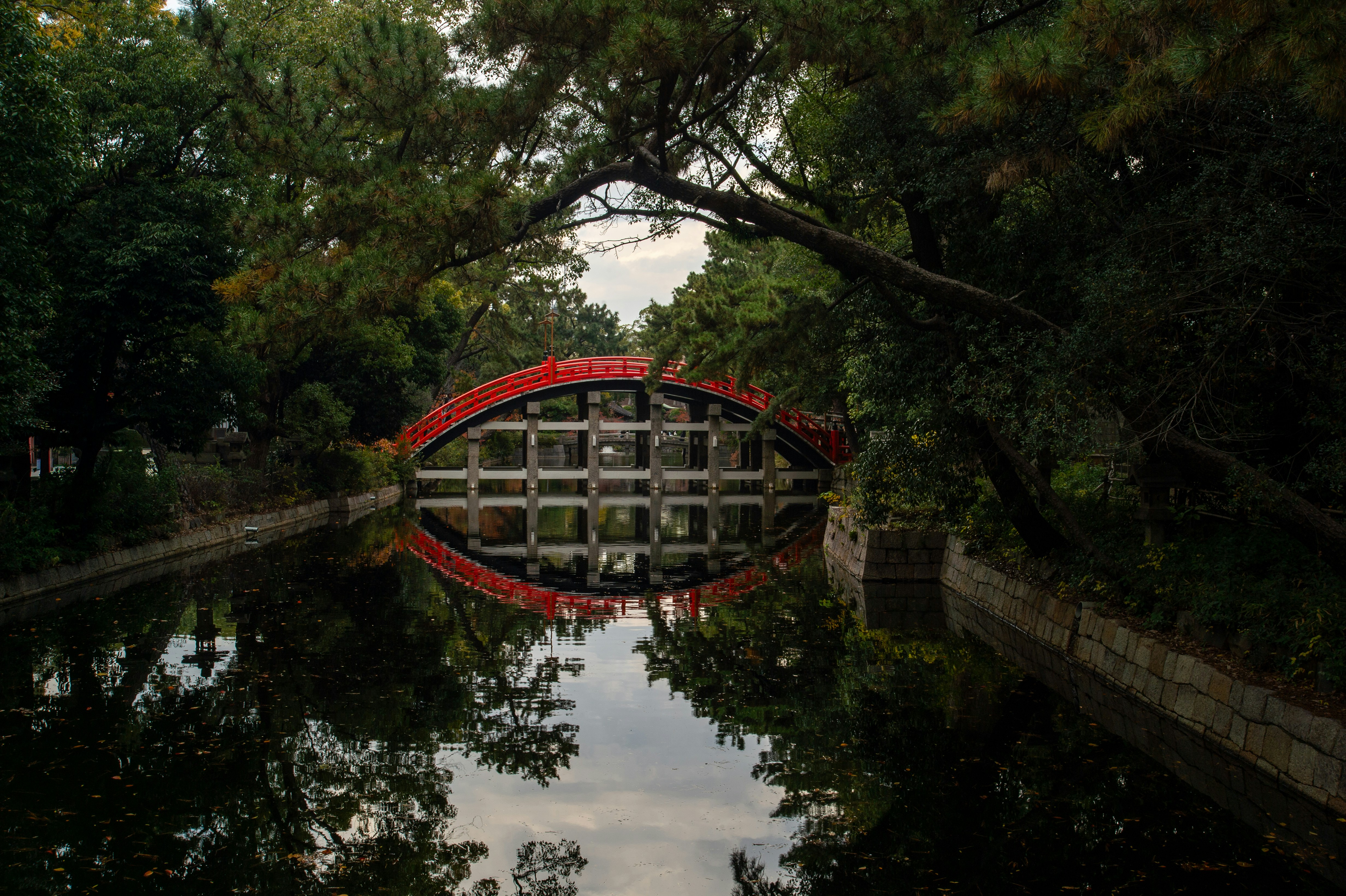 Red Bridge in a Quiet Canal: Symmetry and Stillness