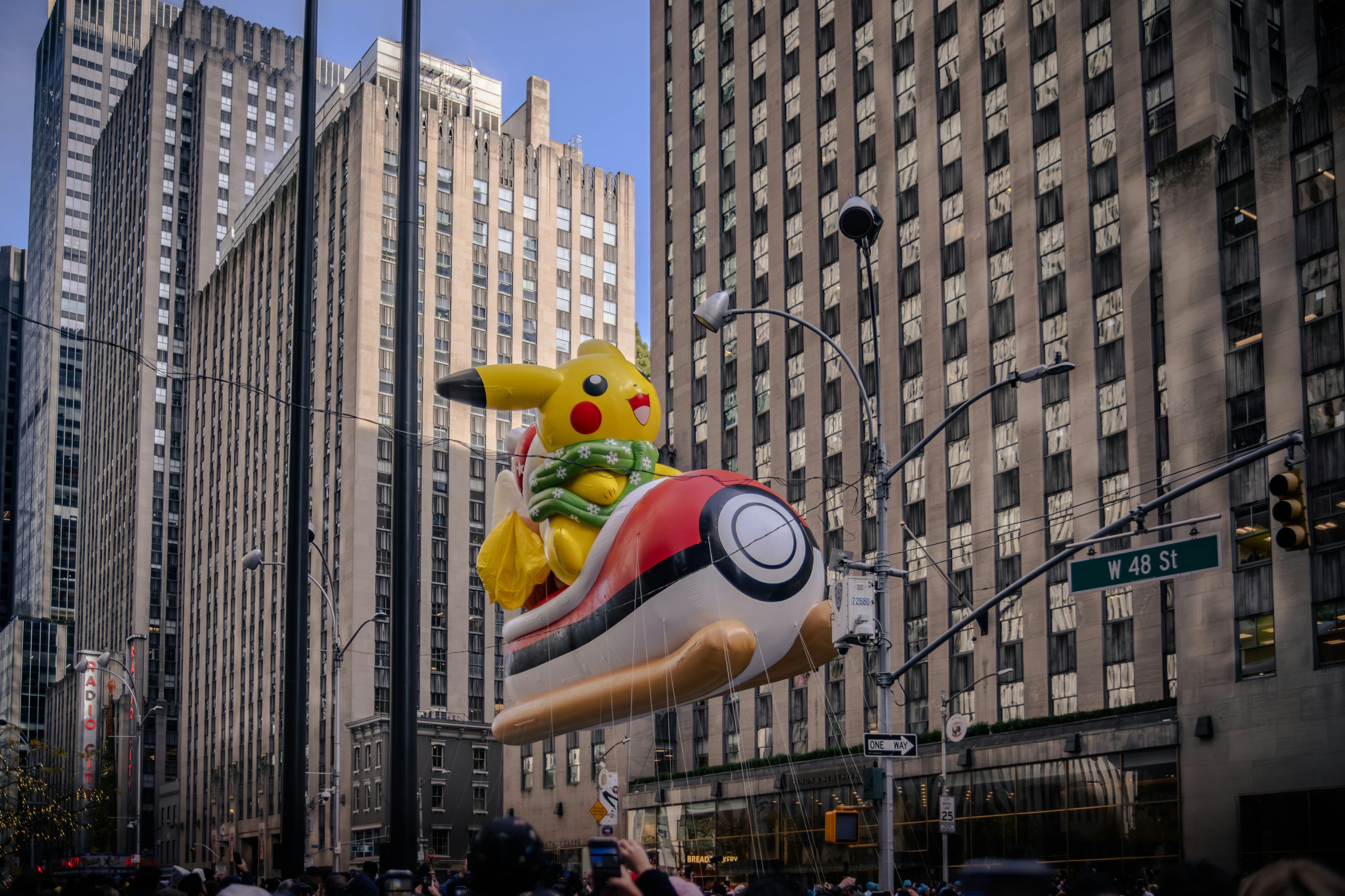 Floating Parade: Pikachu Balloon Rises Above a City Street