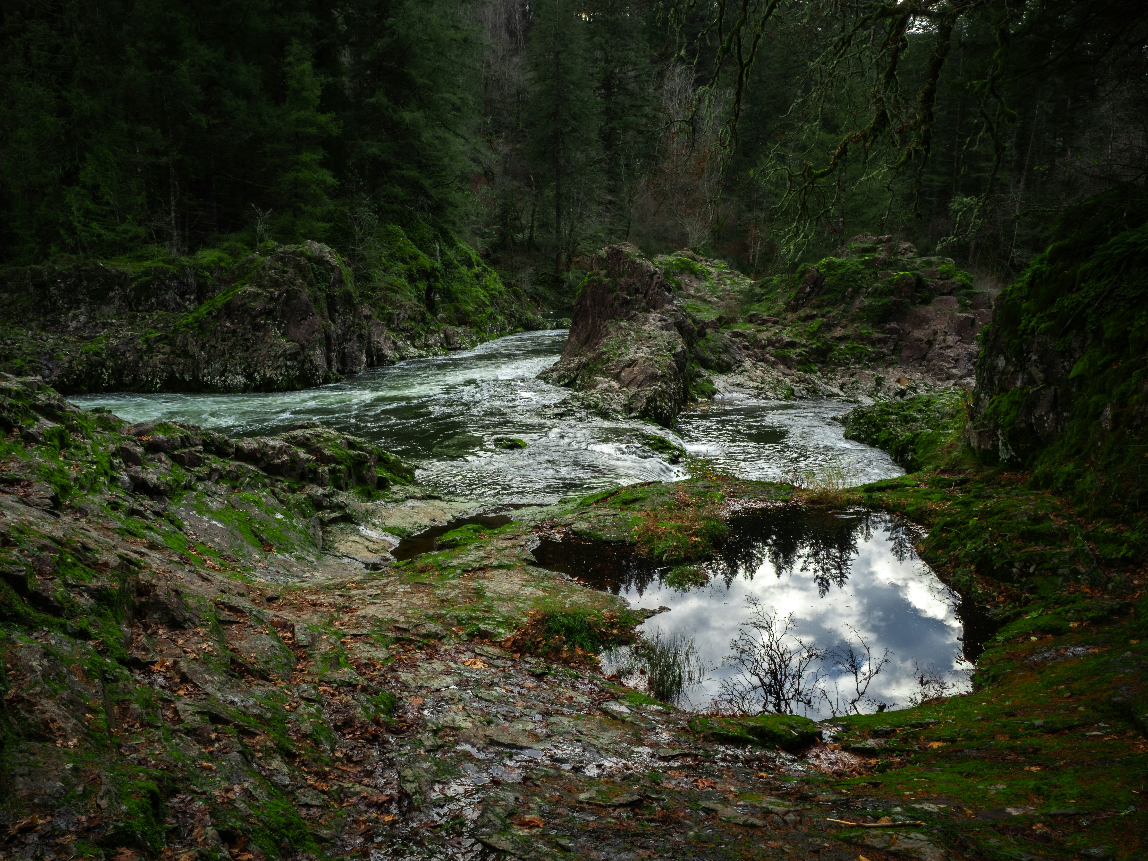 Reflections of the cloudy blue sky at Lucia Falls, Washington State.