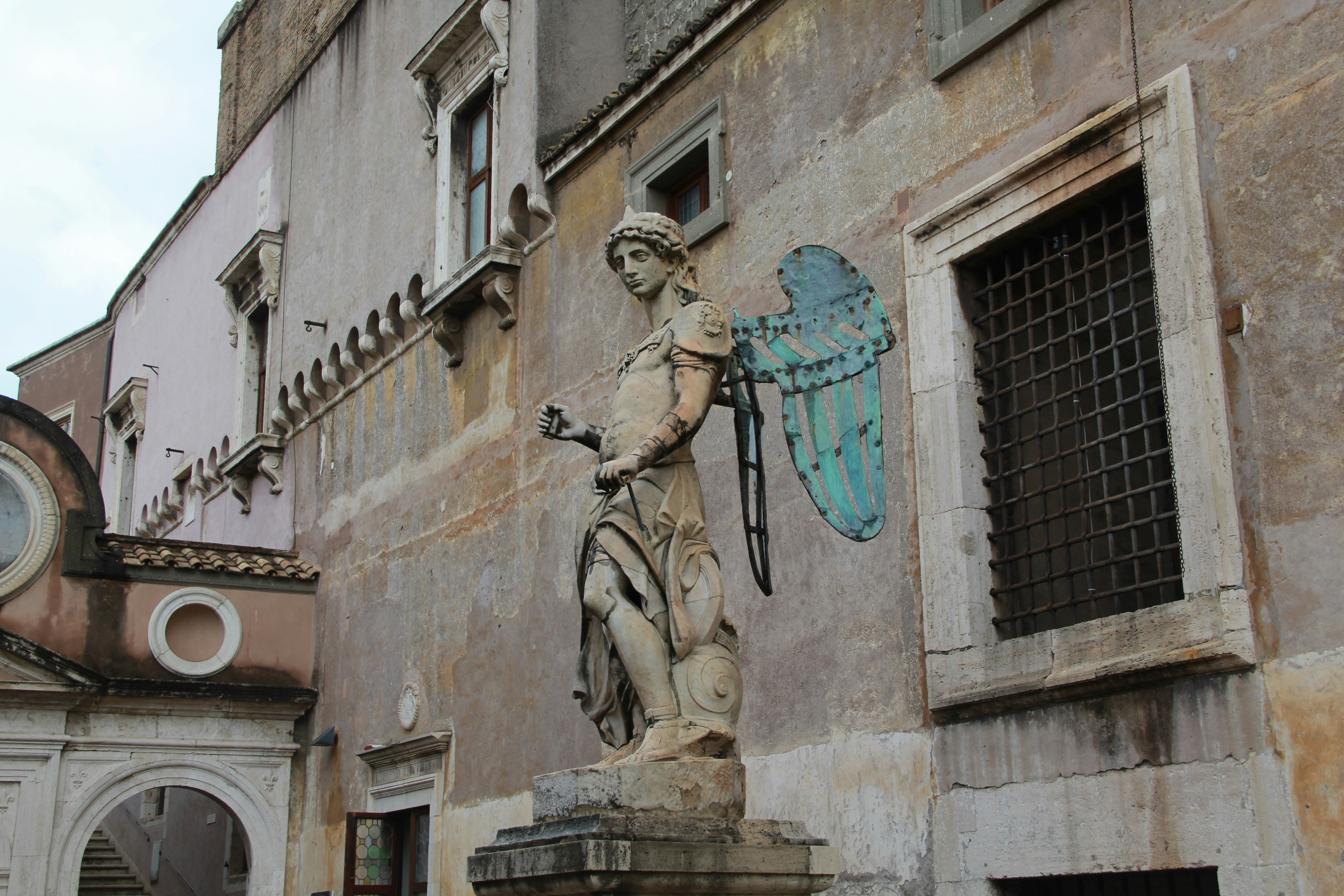 Winged Guardian on Weathered Facade