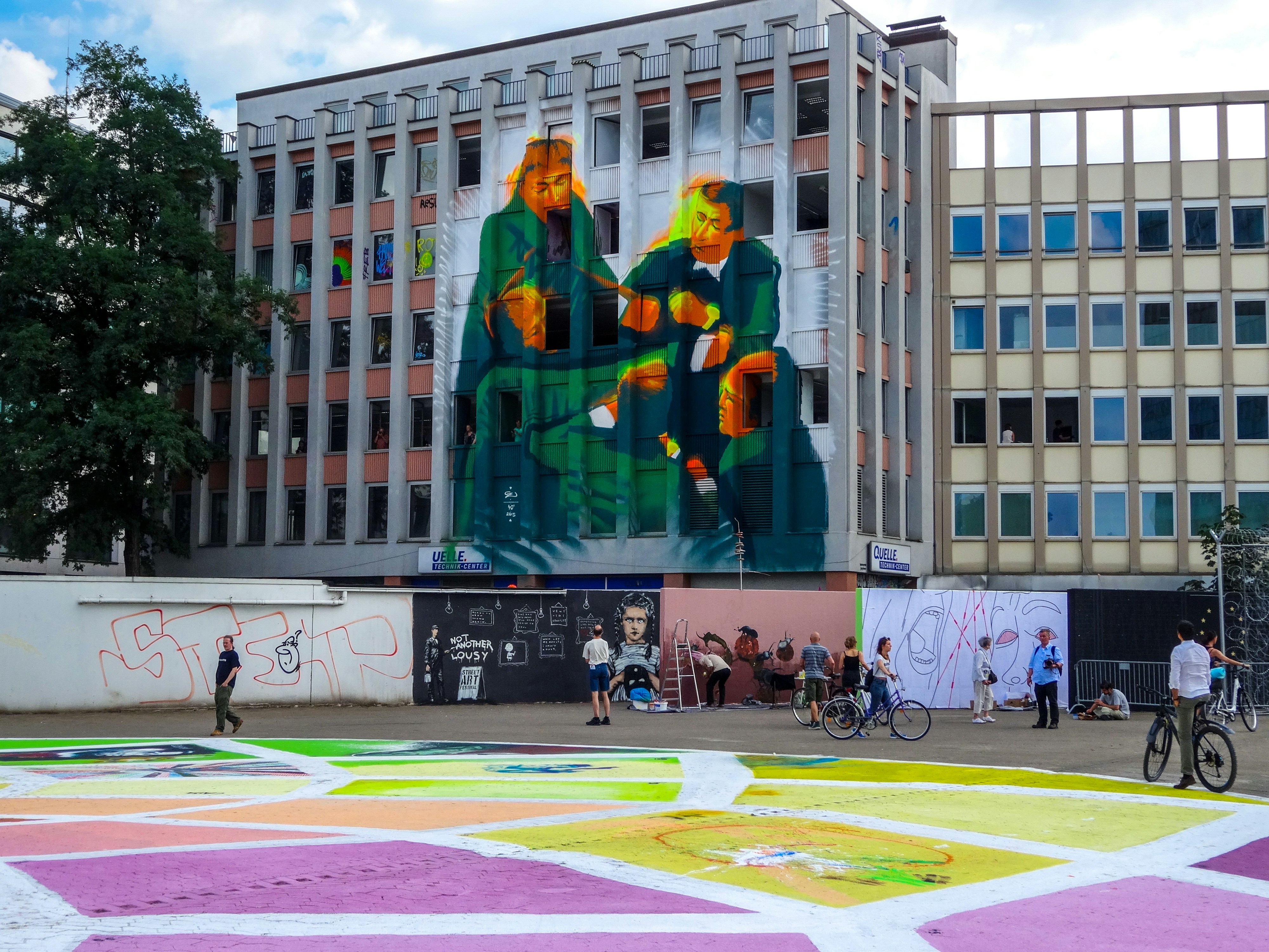 Mural Giants: Color Blocks Overlook a Busy City Square