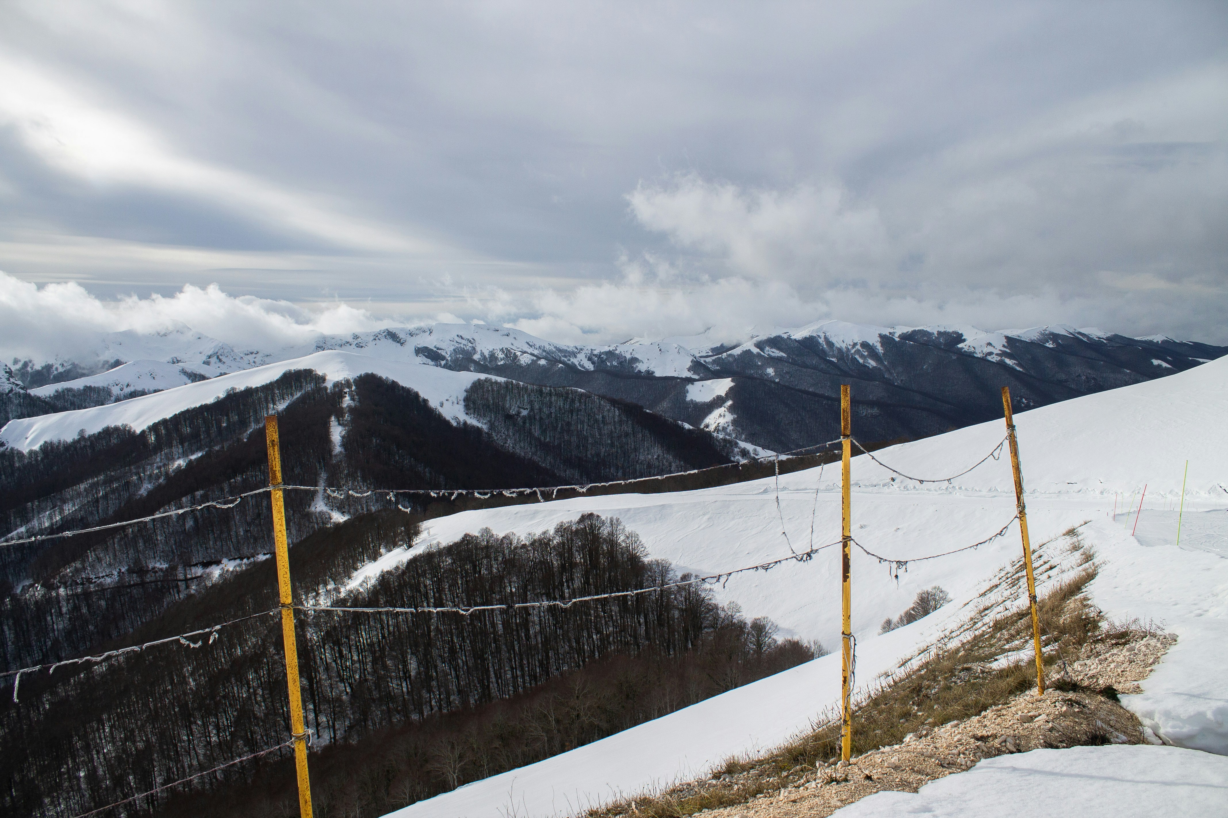 Snowy Ridge Fence: A Quiet Verge Between Snow and Sky