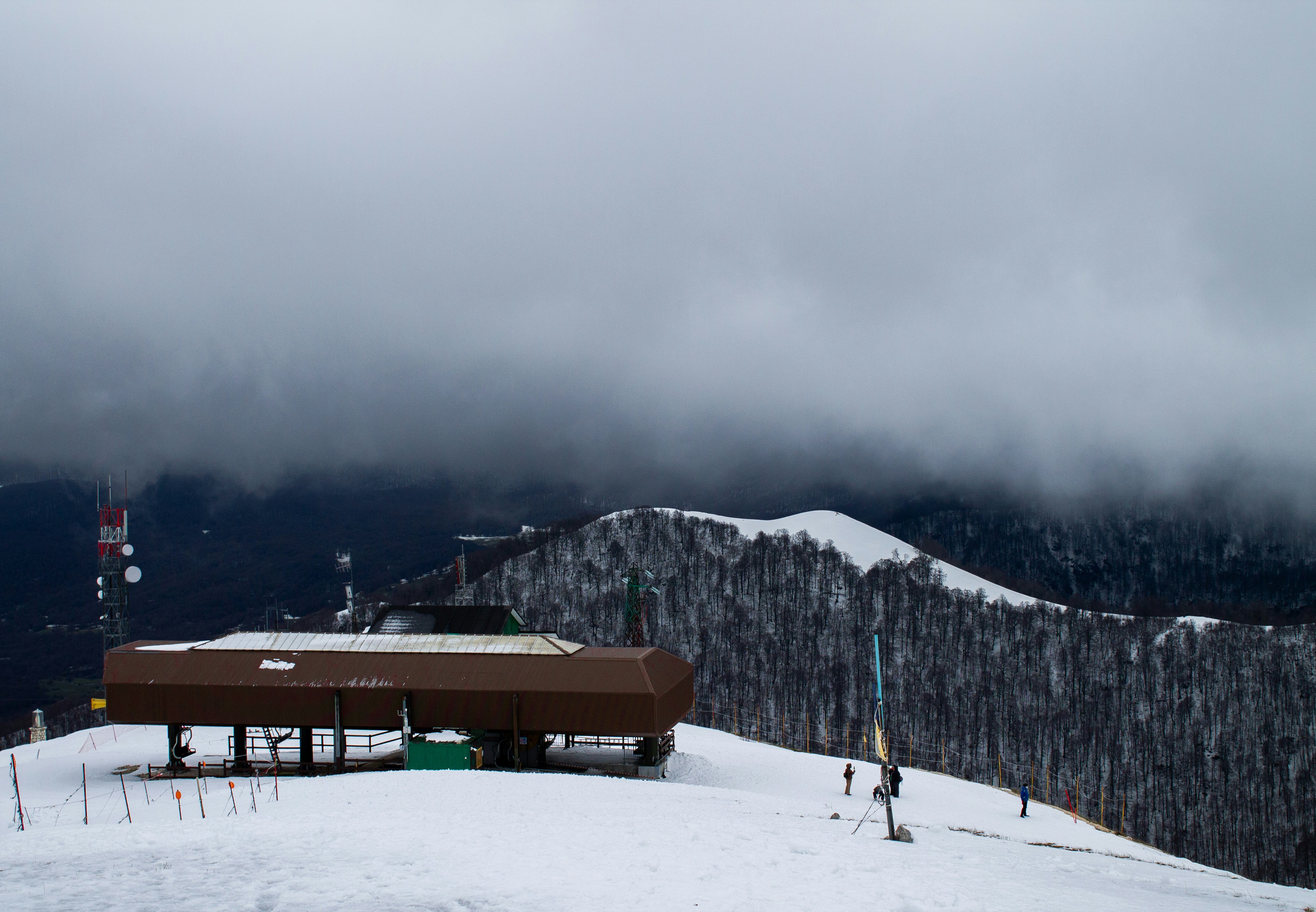 Snowbound Summit Station Beneath a Low-Cloud Roof