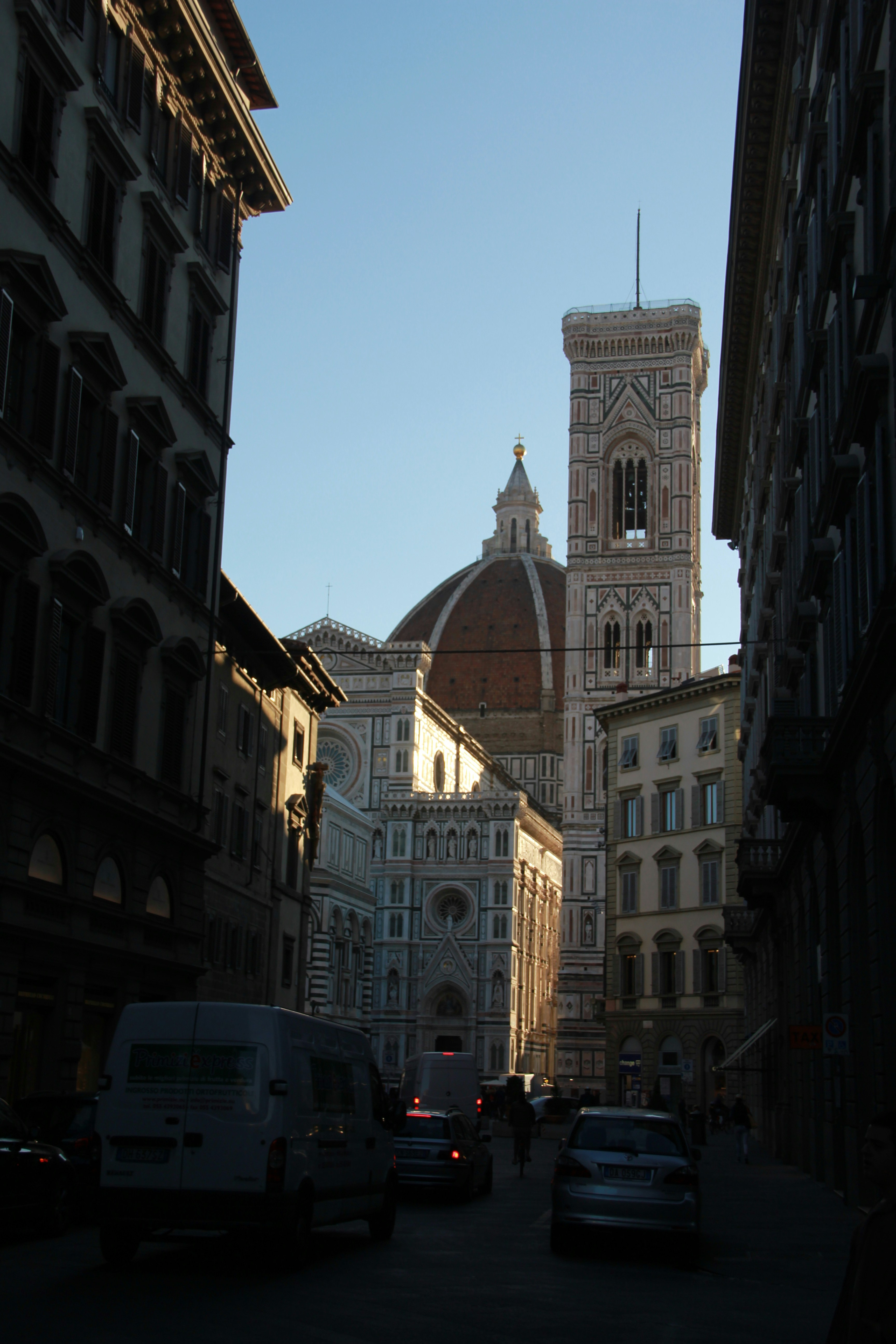Sunlit Tuscan Cathedral Silhouette Over a Narrow Florentine Street