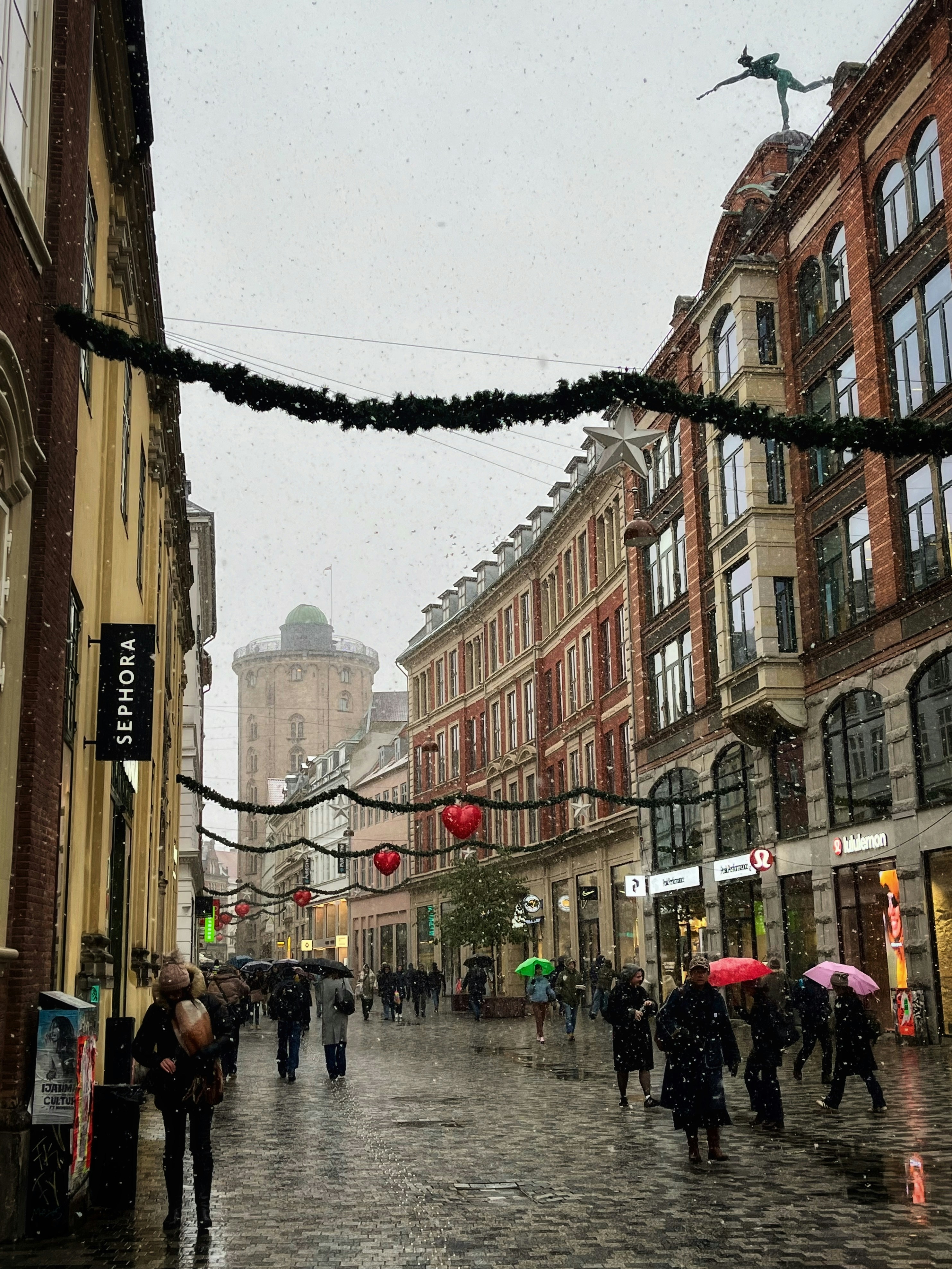 Snowy Baltic Street: Christmas Decorations, Crowded Pedestrian Corridor