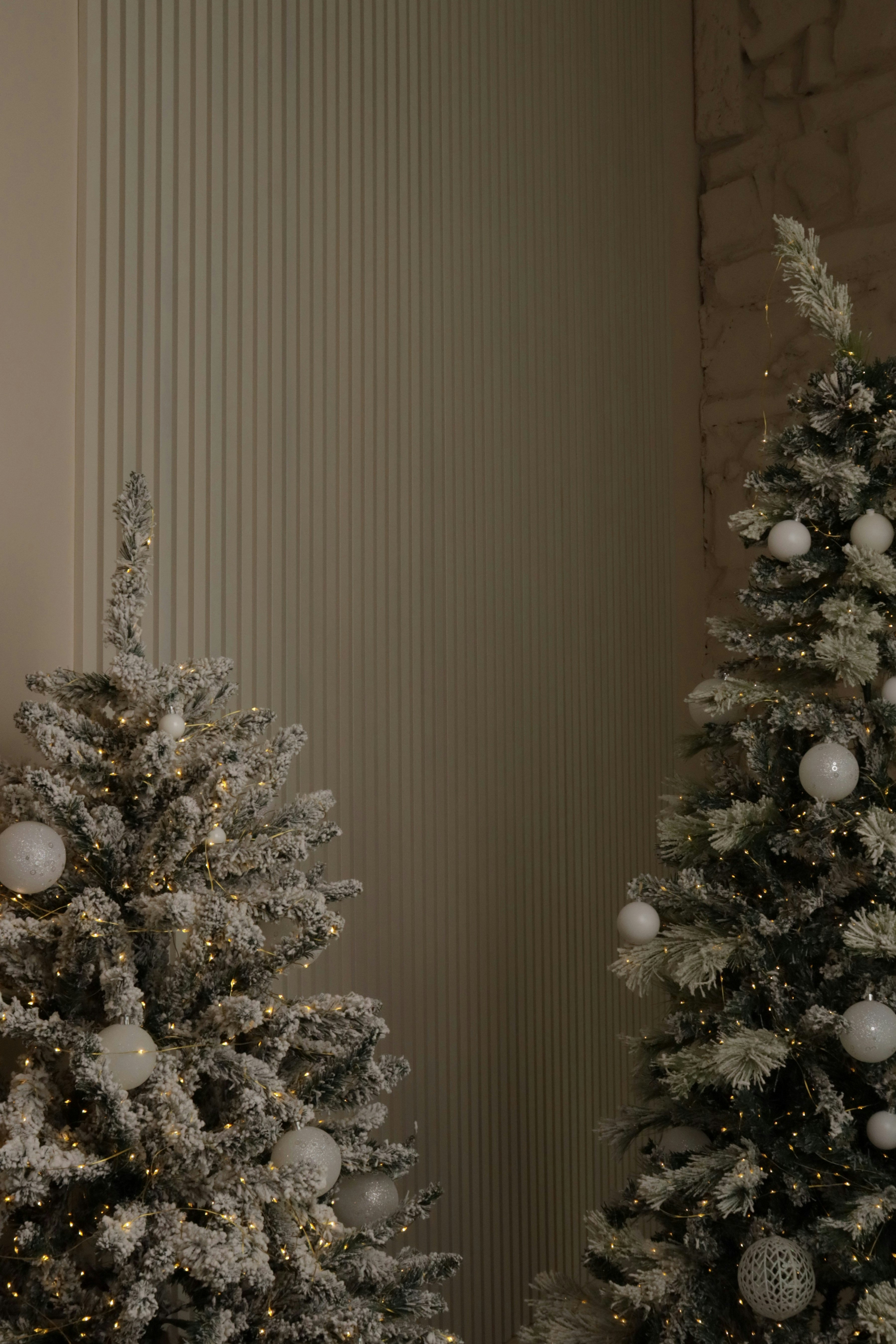 Winter Glow: Snow-Frosted Christmas Trees in a Cozy Corner