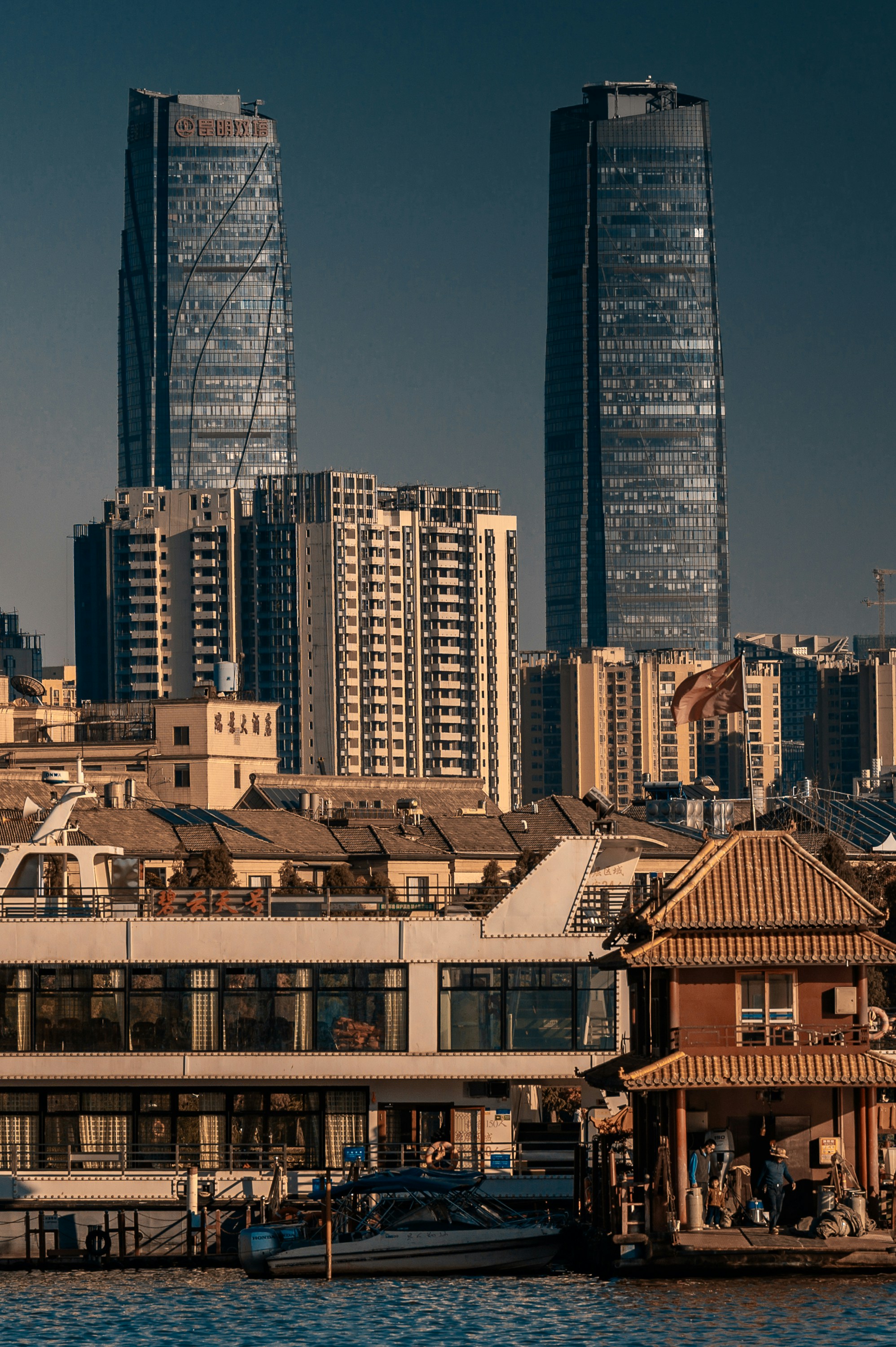 Skyline Convergence: Boats, Bridge, and Tower Reflections