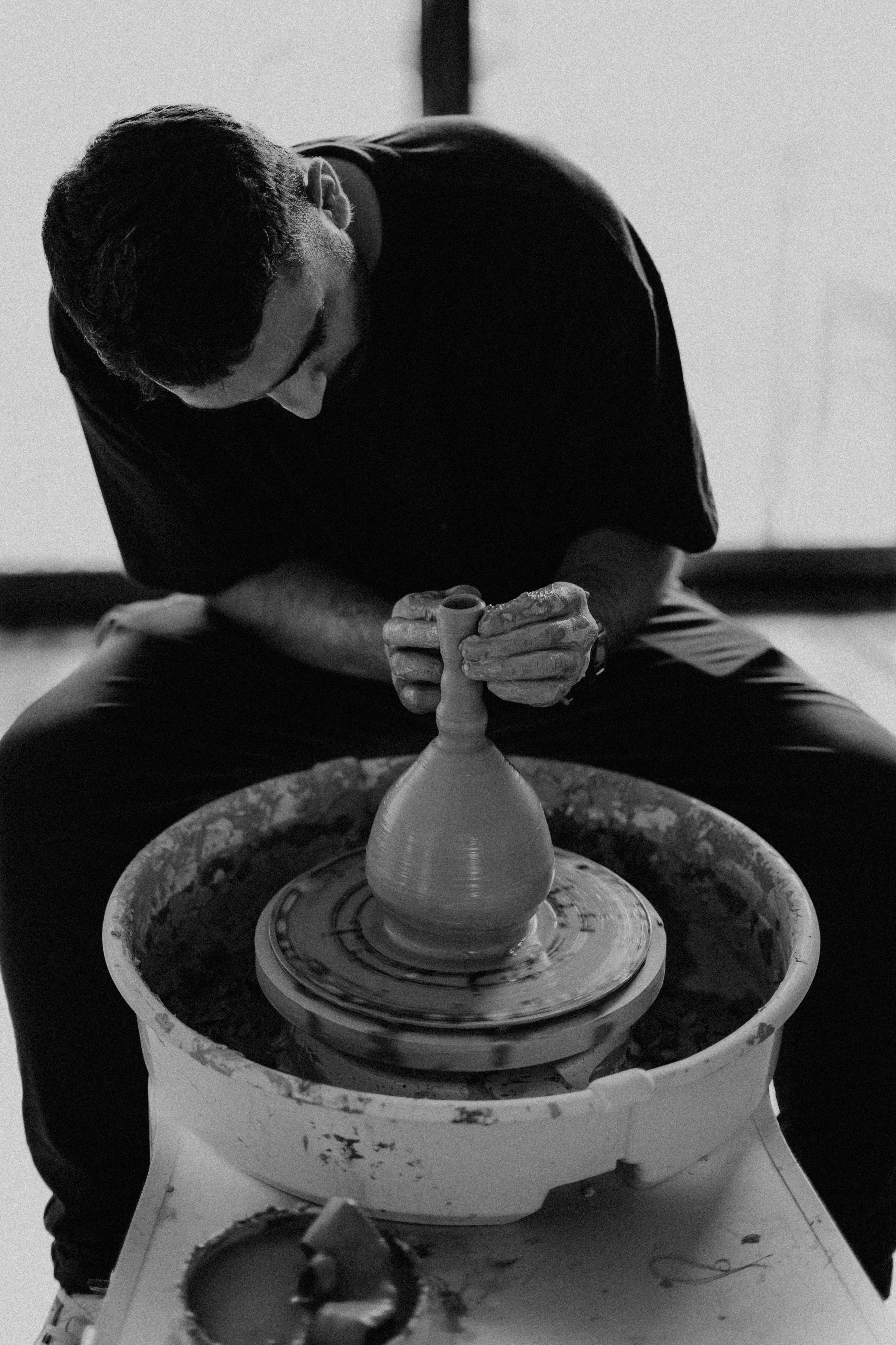 Man shaping clay on a pottery wheel photo – Free Studio Image on Unsplash