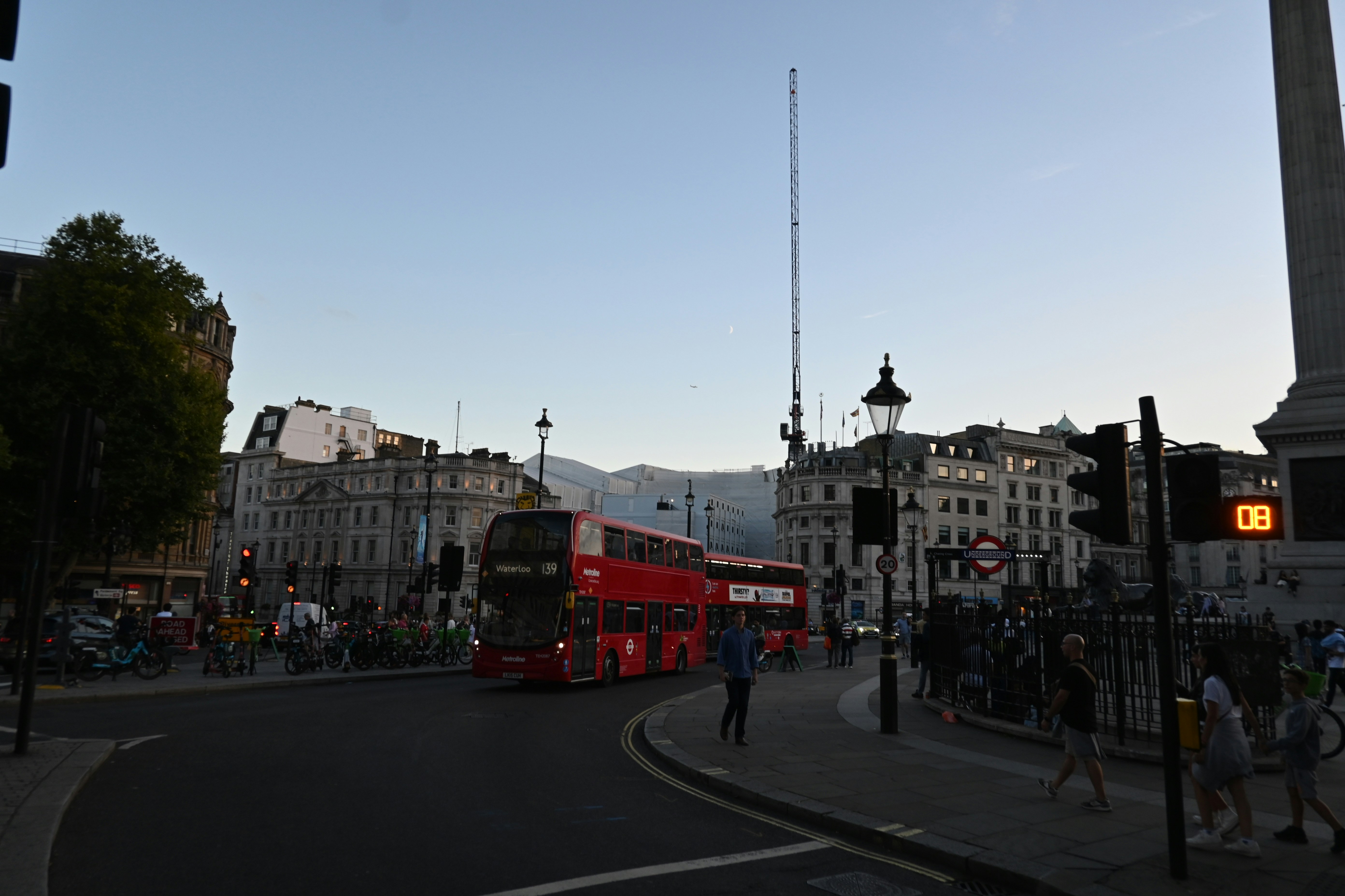 Red Double-Decker at a City Crossing