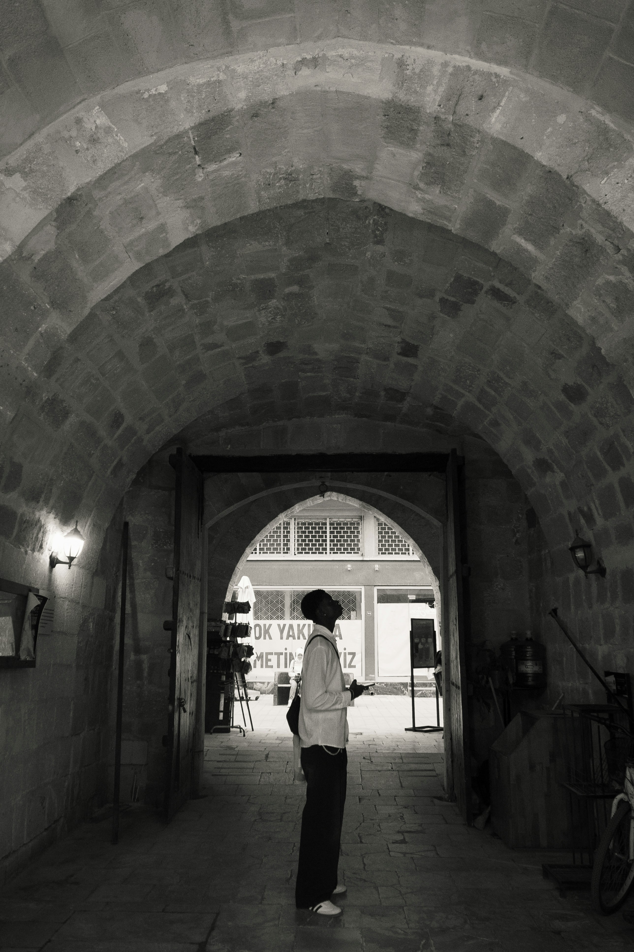 Between Archways: A Quiet Portrait in the Stone Corridor