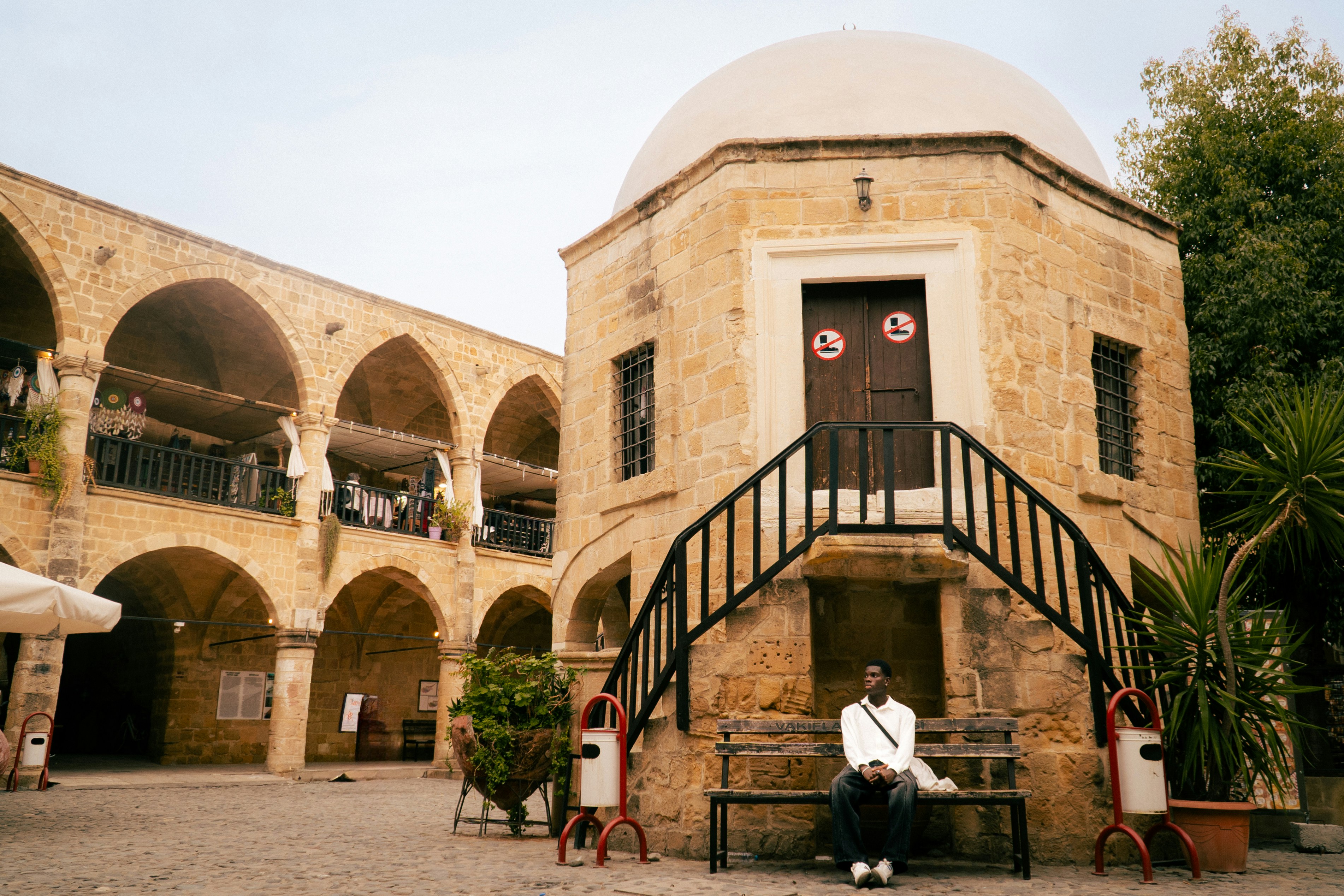 The Staircase Sentinel: A Solitary Figure at the Dome-Top Chapel