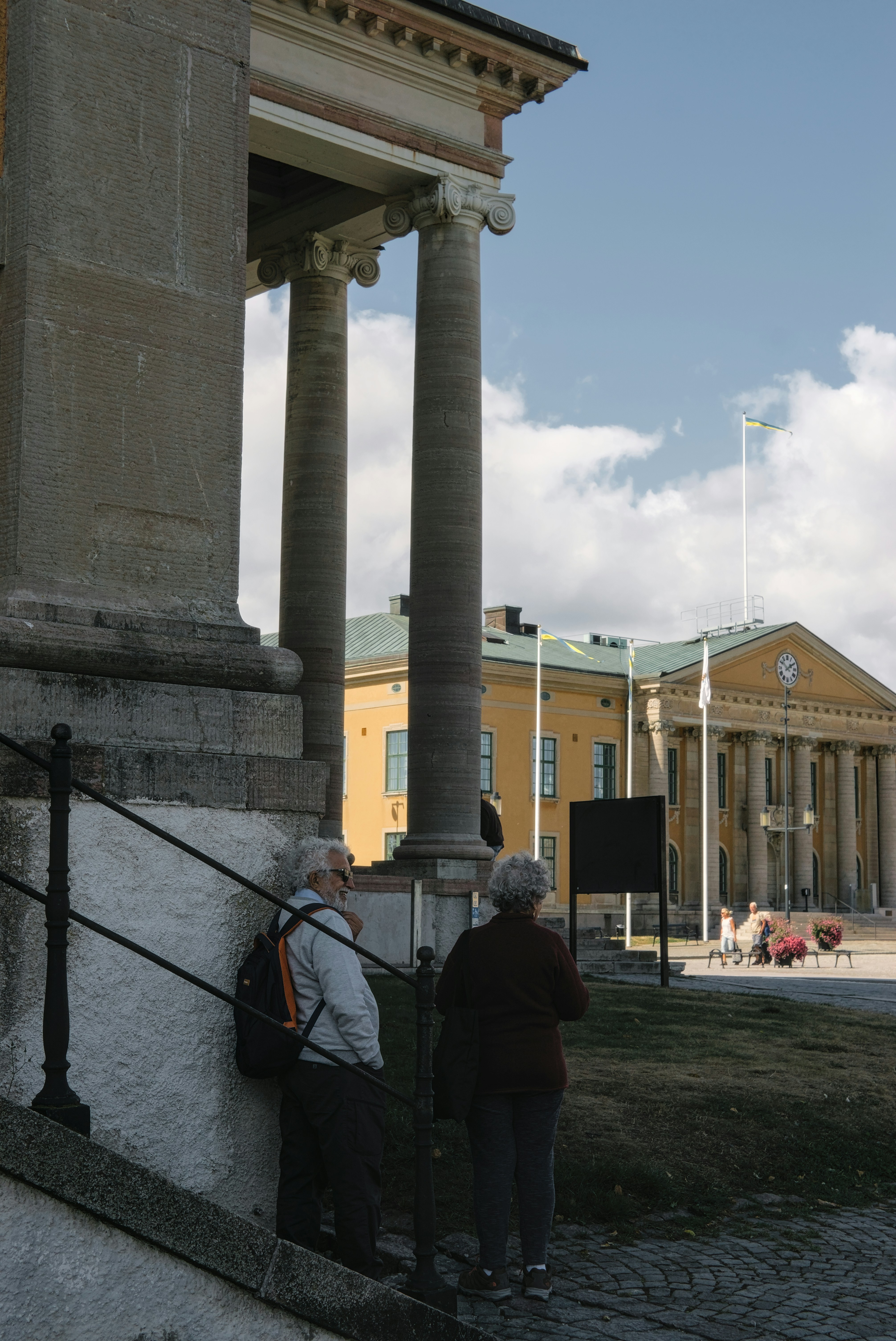 Under the Columned Porch: Elderly Couple at a Town Hall Square