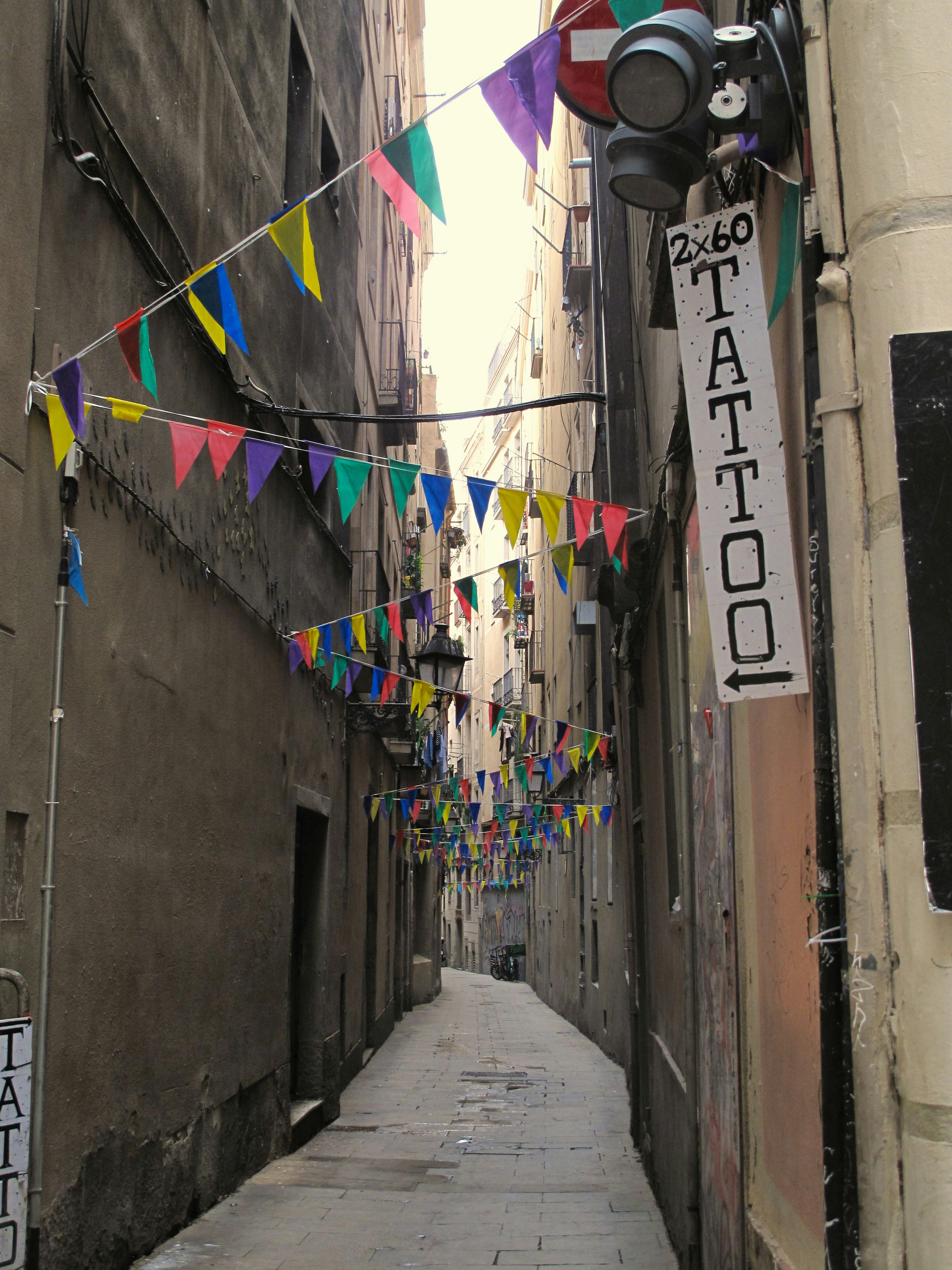 Narrow european alley decorated with colorful flags