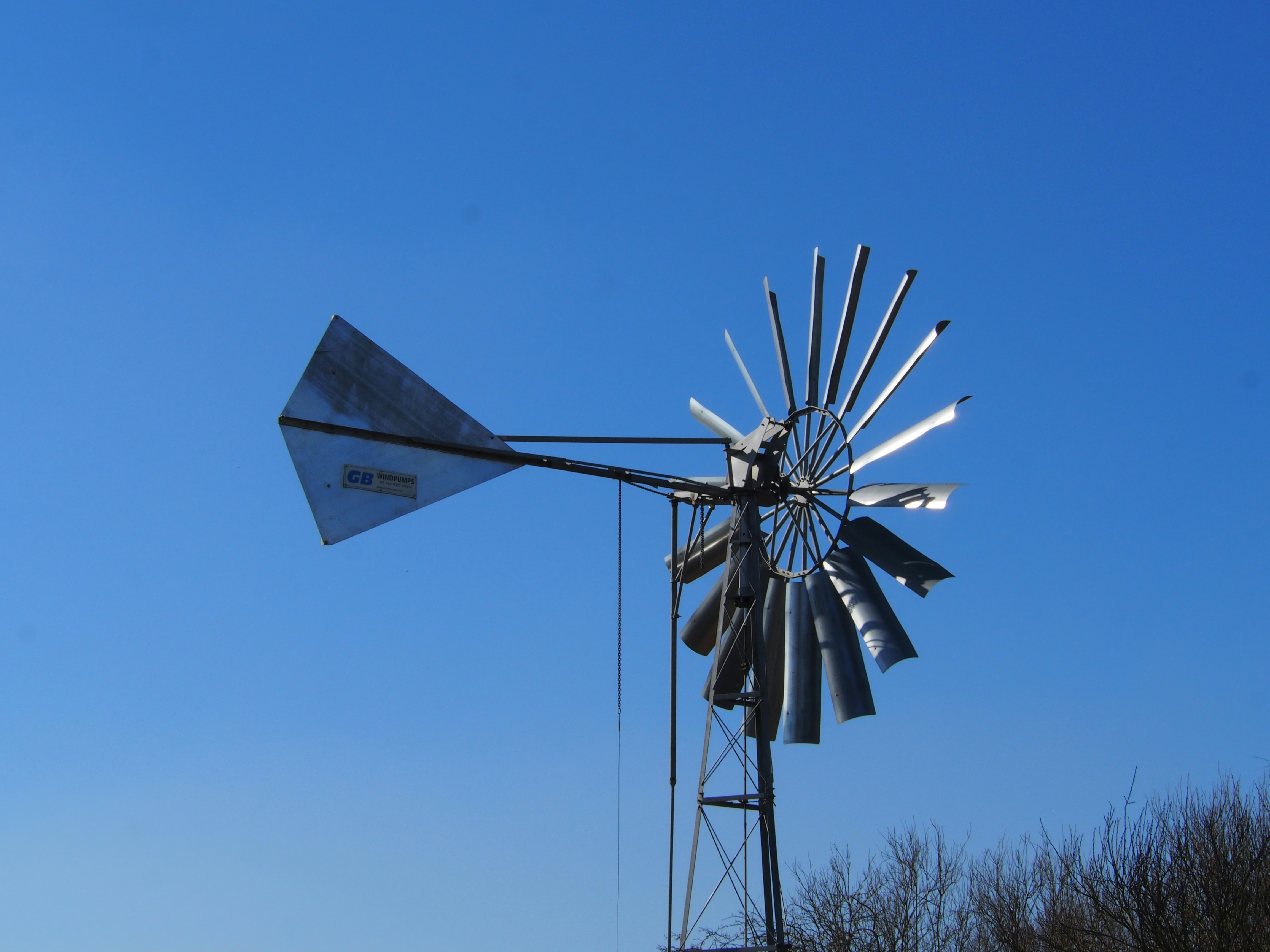 Windswept Wheel: A Lone Windmill Under Open Skies