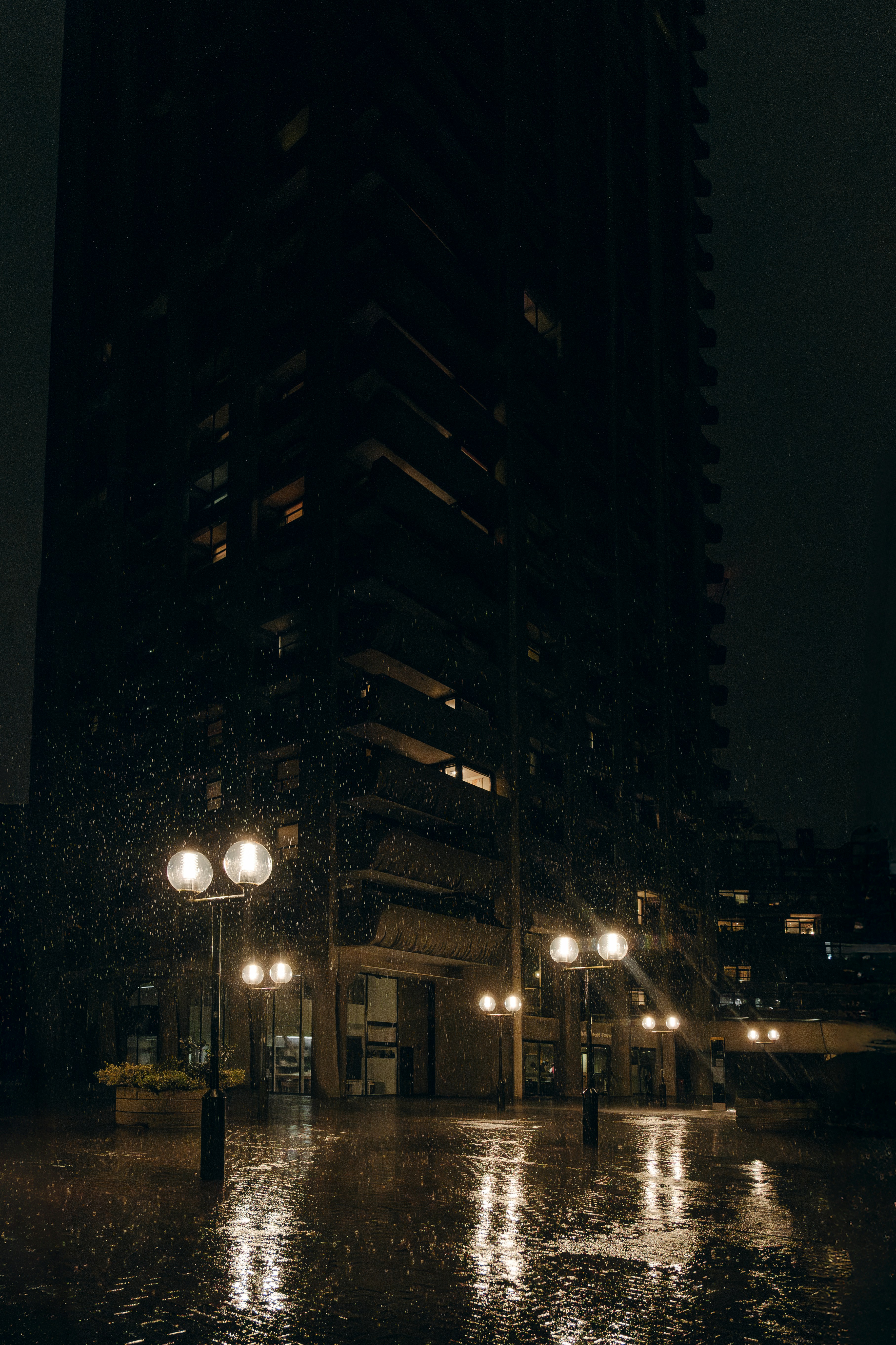 Night Rain, City Glass: Neon Reflections on a Wet Plaza