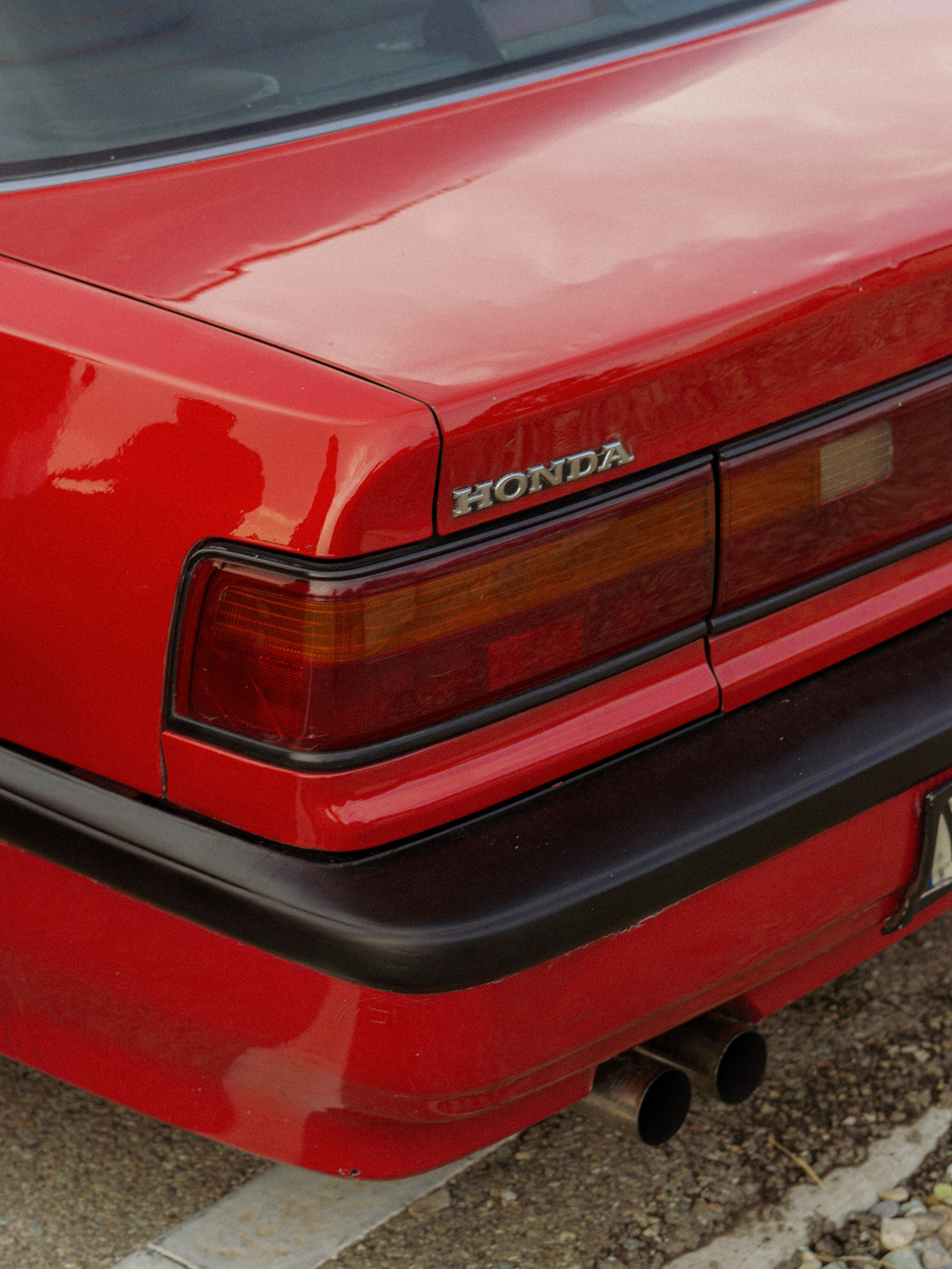 Red Honda Tail: A Quiet Echo of a Car's Late-Night Stance