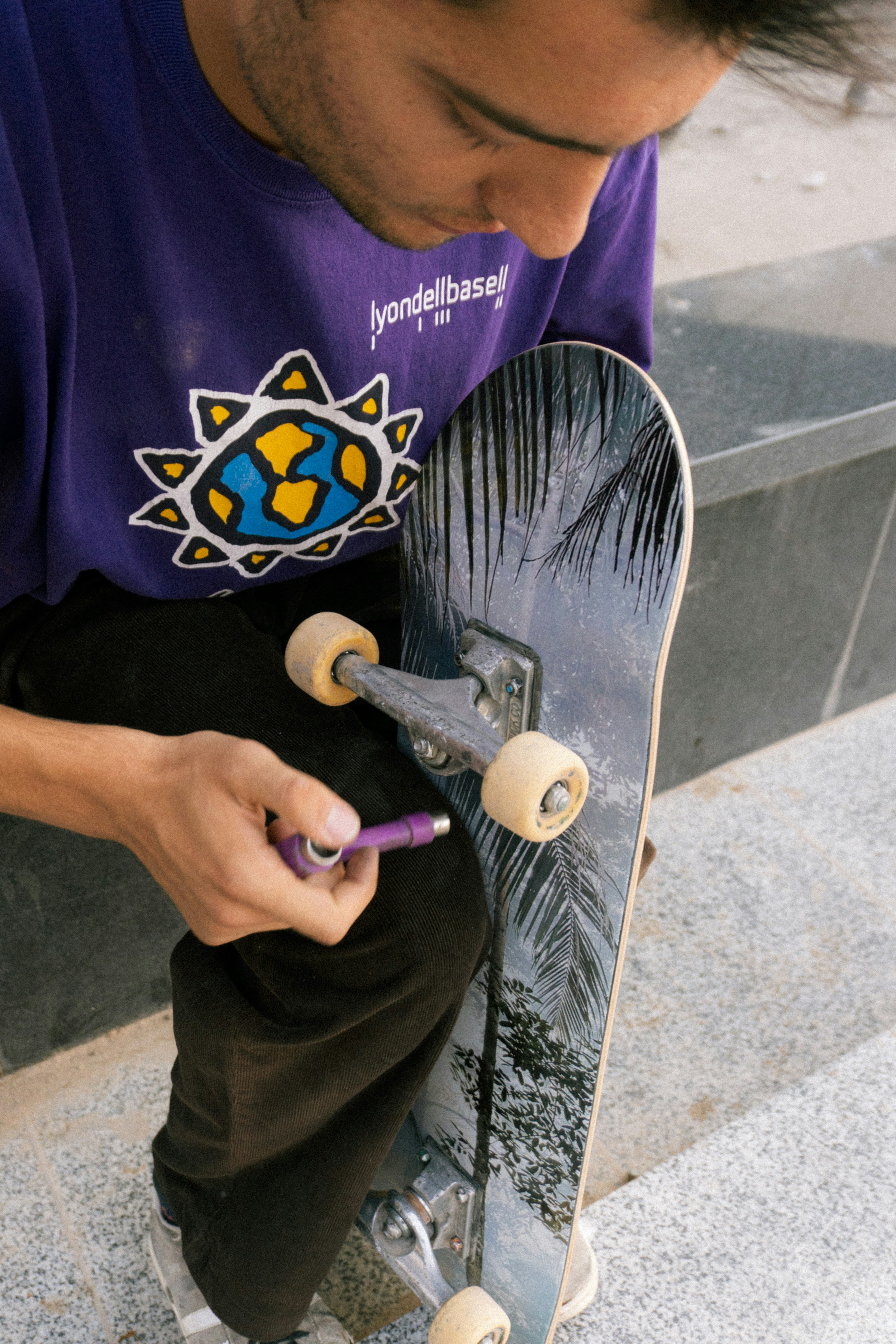 Focused Resolve: Skater Adjusts the Board Under Soft Street Light