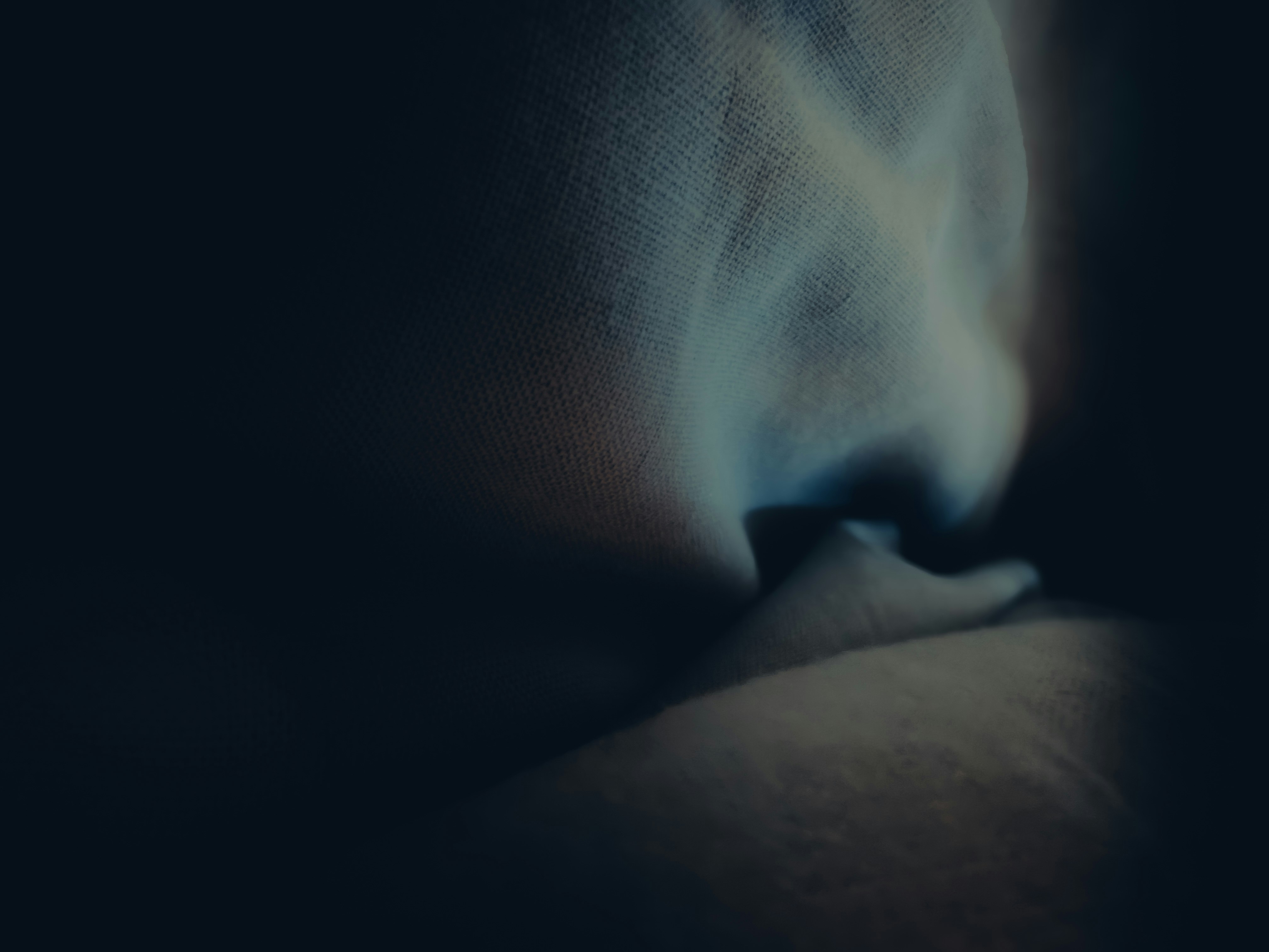 Veiled Quiet: A Sliver of Light on Folded Fabric