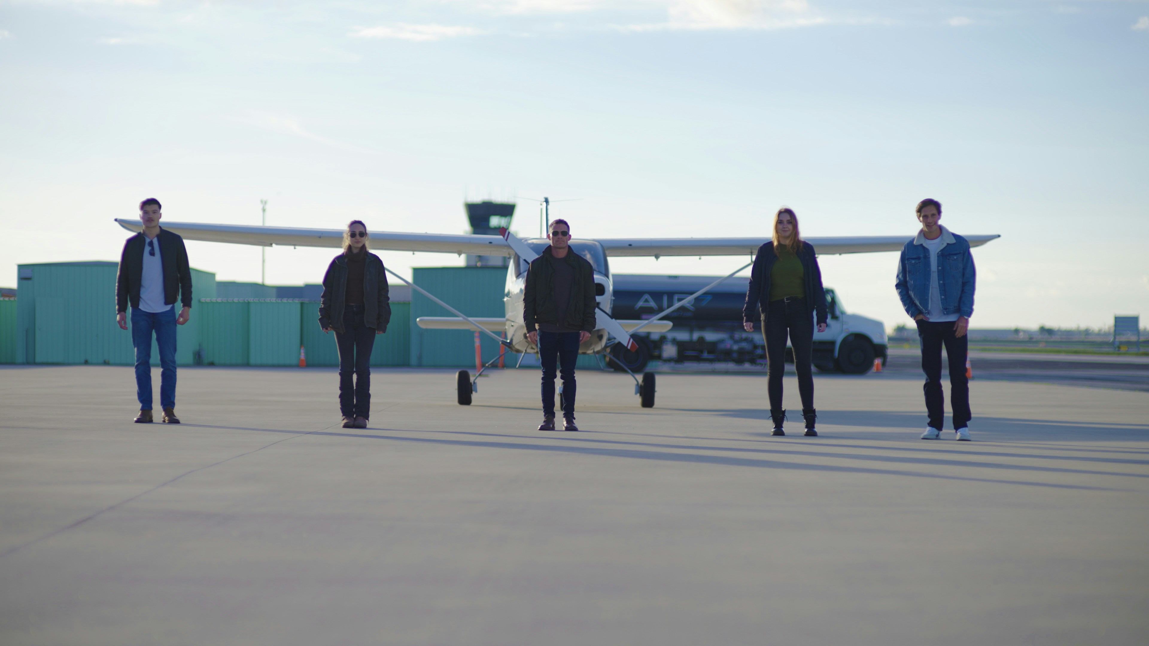 Five people stand on an airfield near a small airplane. photo – Free ...