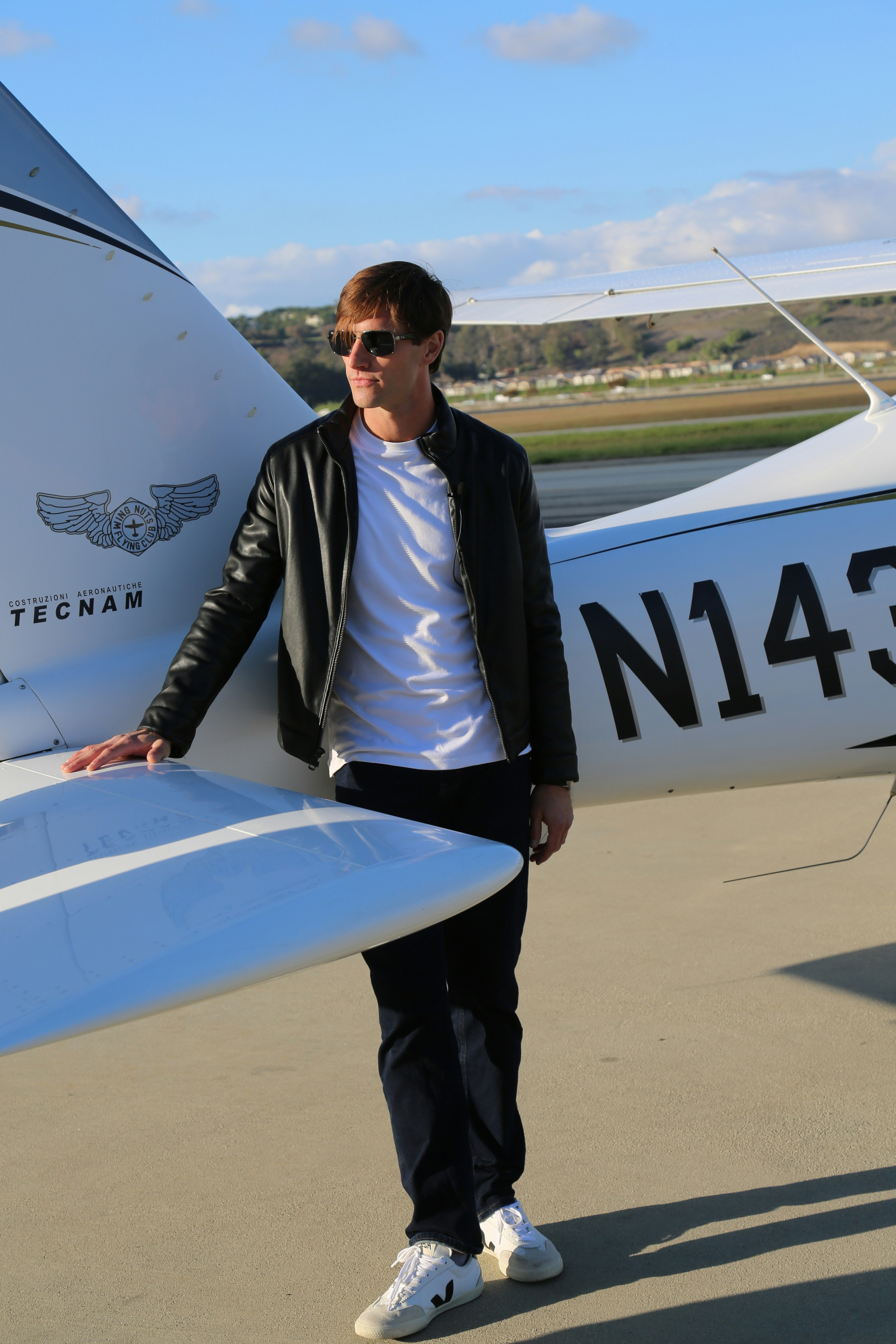 Pilot at the Wingtip: A Quiet Moment by a Small Aircraft