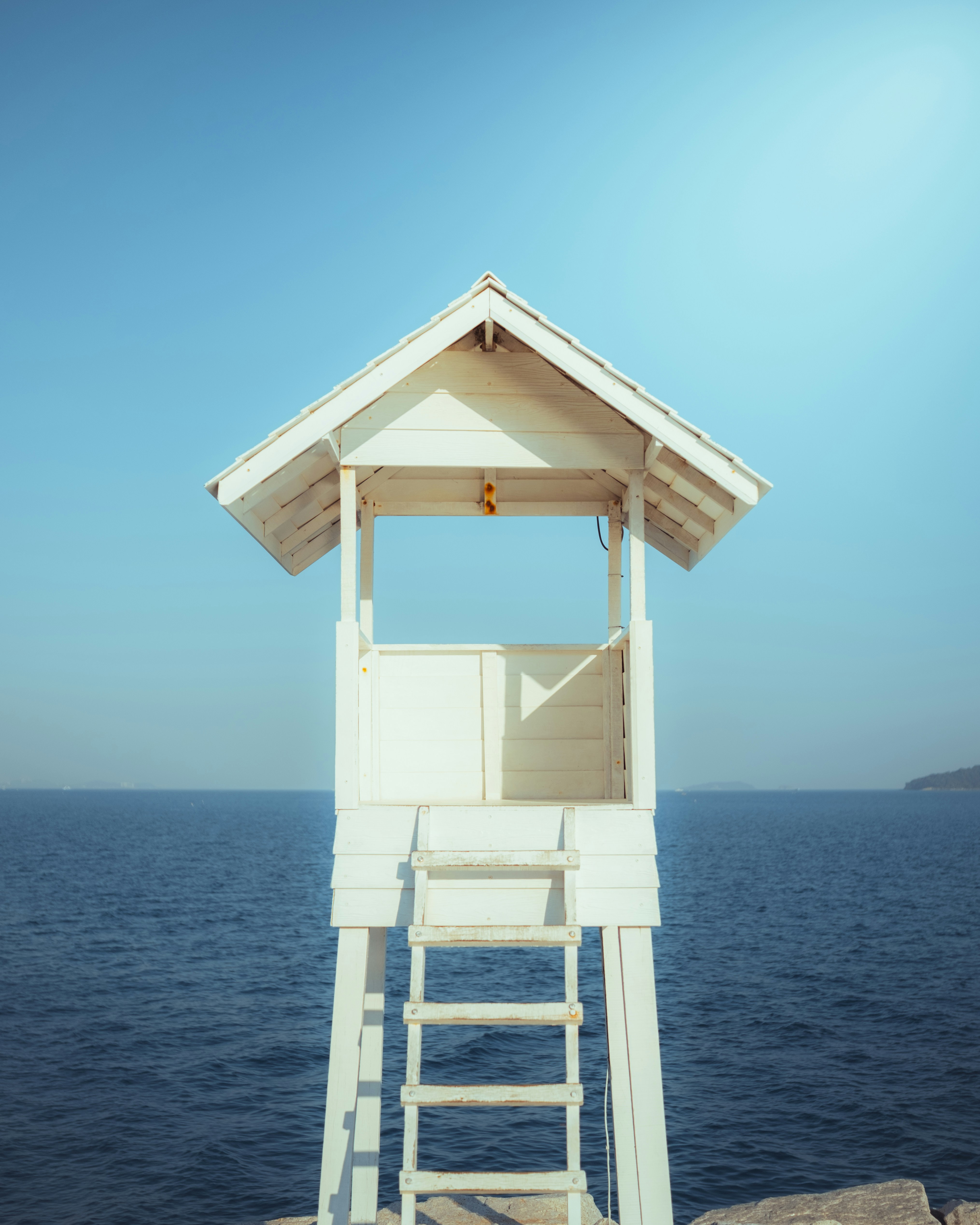 White Beach Hut Rising Over Quiet Indigo Seas