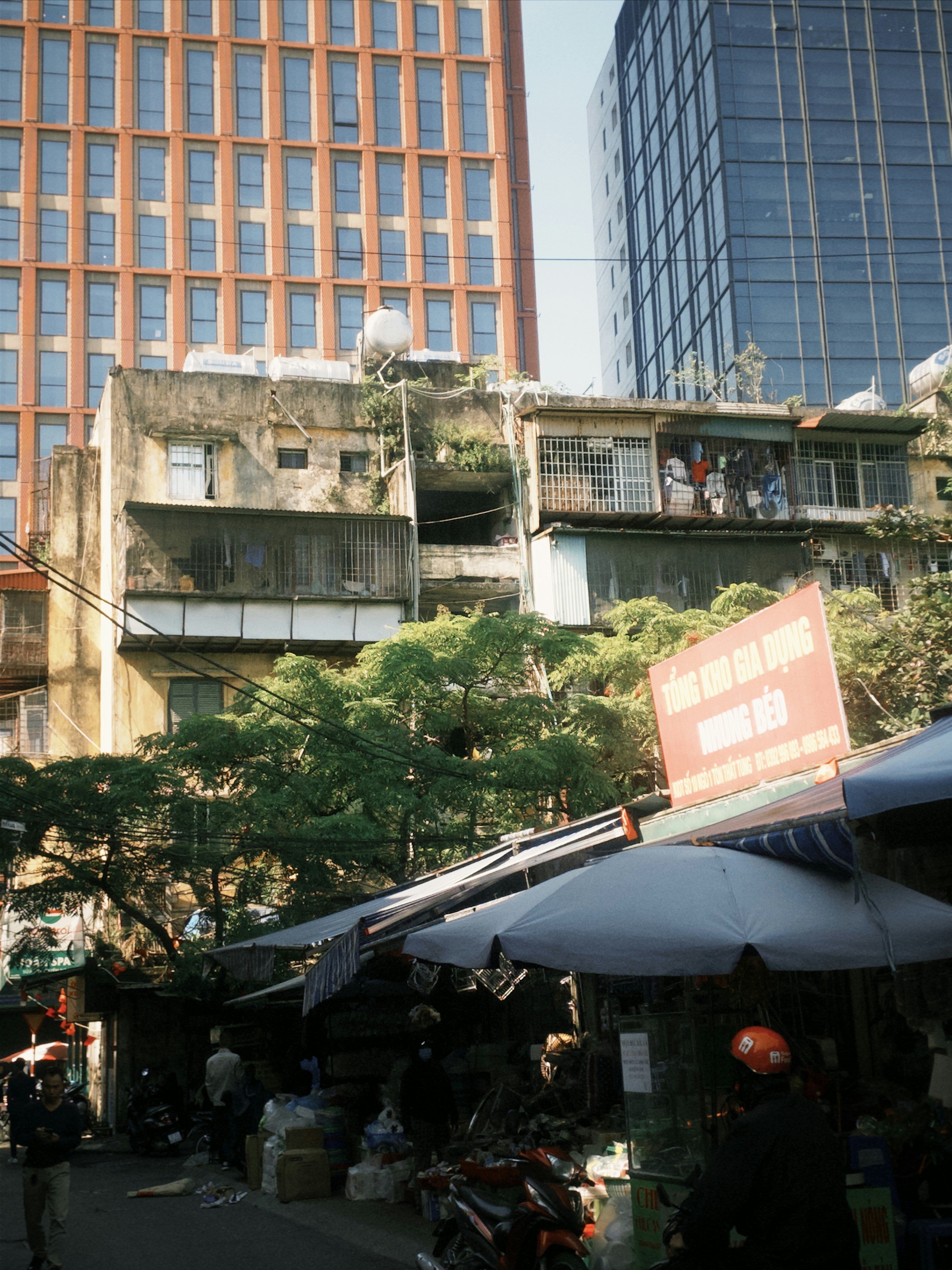 Urban Market Facade Beneath Deteriorating Apartment Blocks