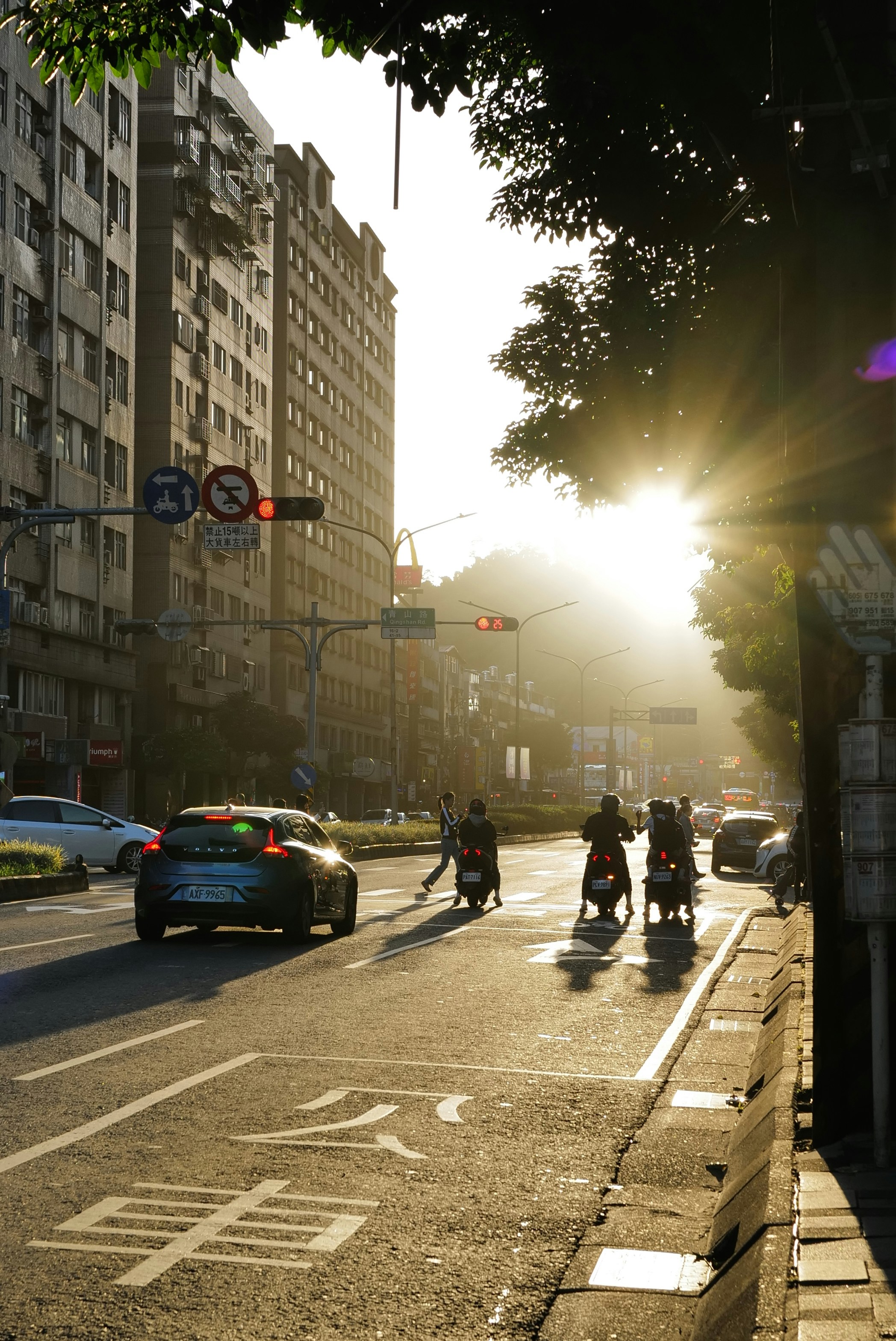 Sunlit Street Ascent: Riders and Rising City