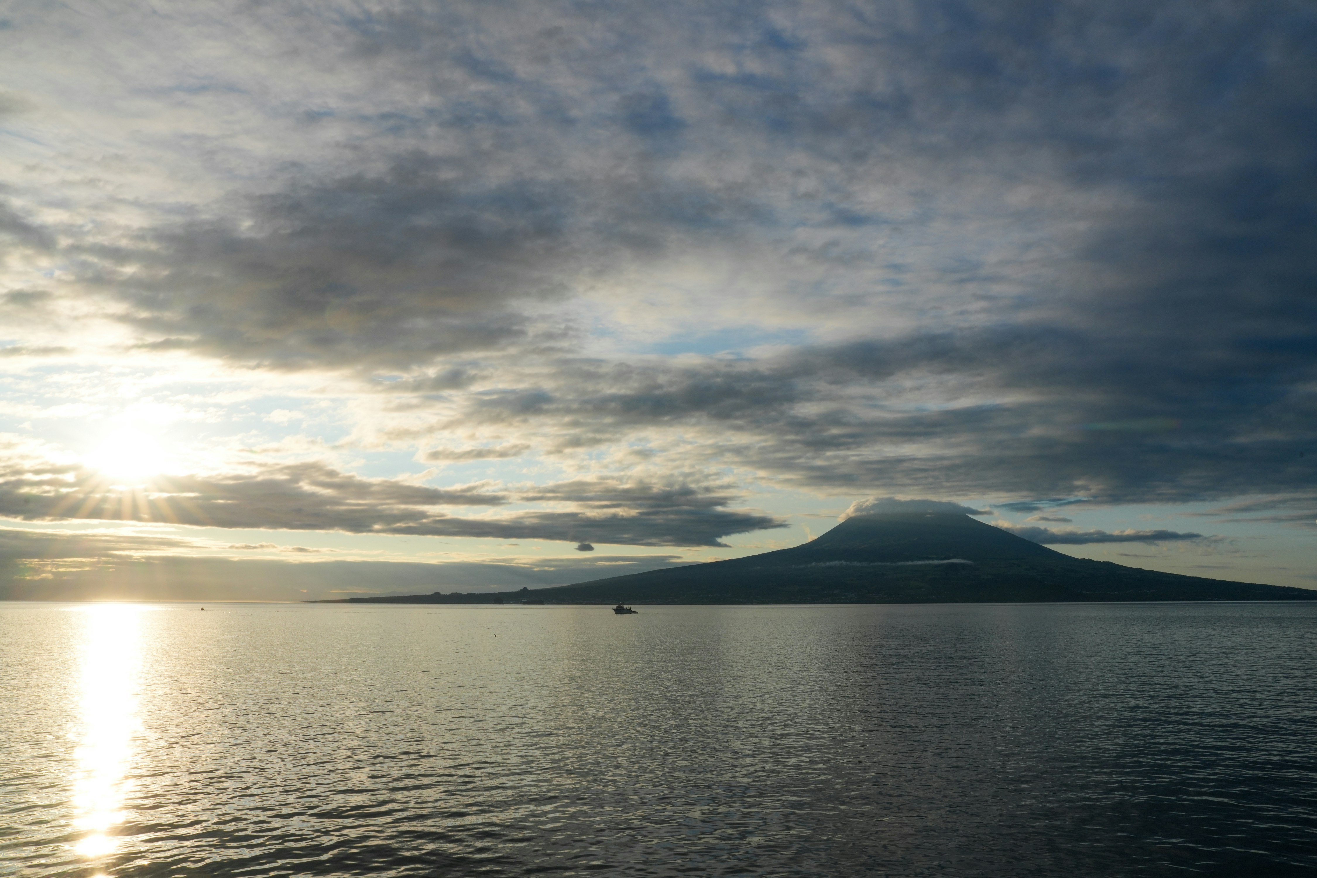 Deserted Horizon: Sunlit Lake Meets Shadowed Volcano