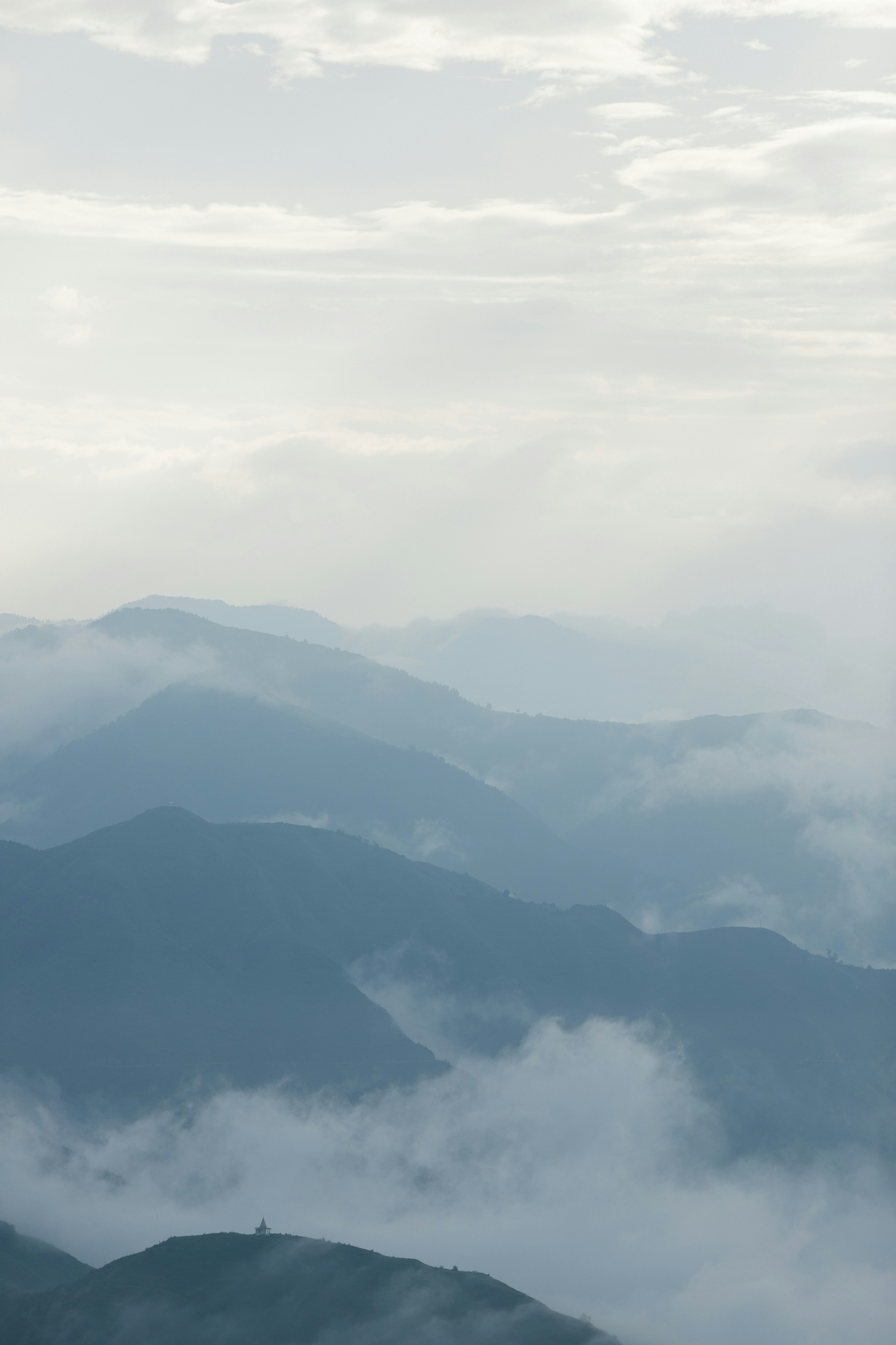 Morning Mist Over the Blue Ridge: Layers of Distant Peaks Rise Through Clouds