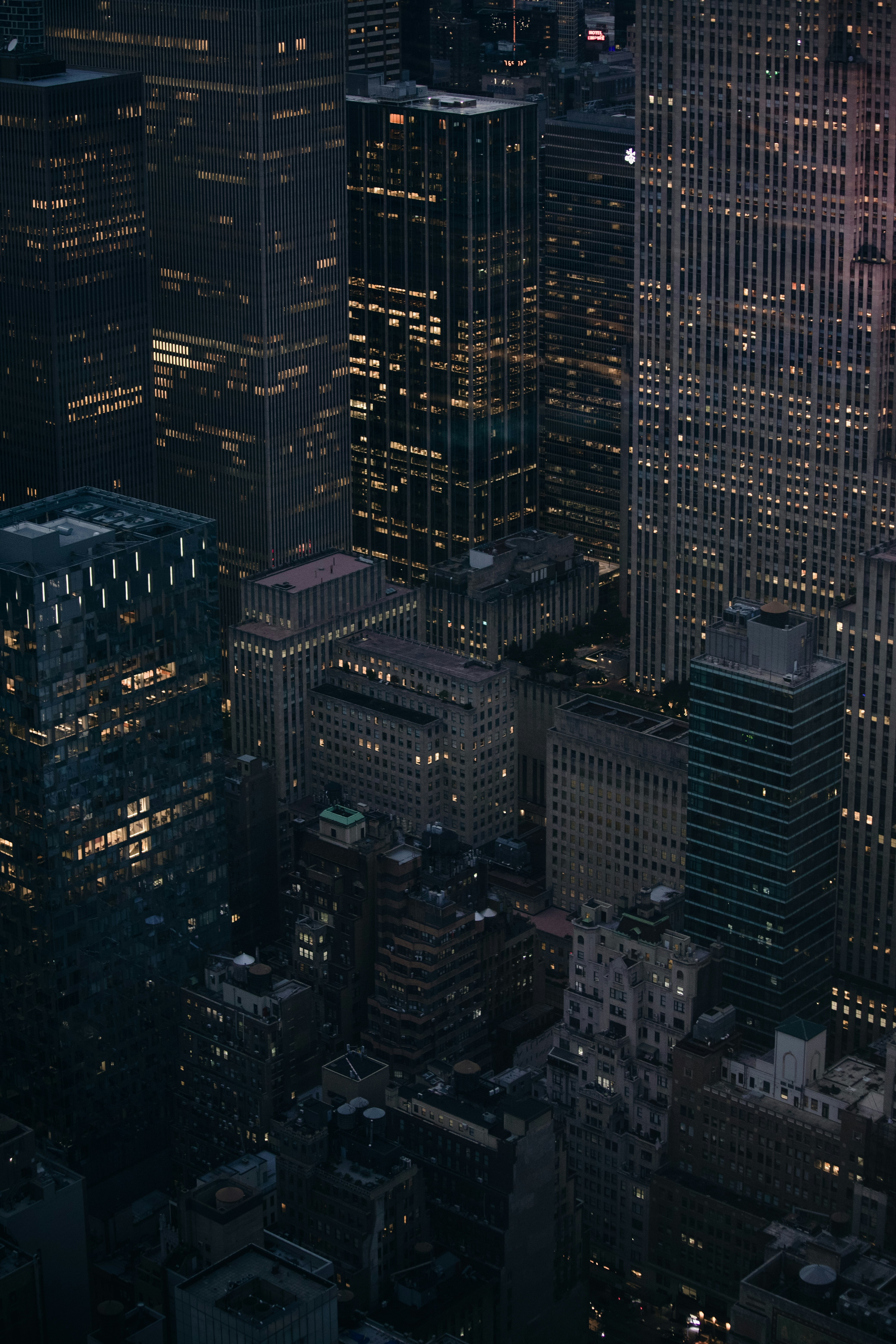 Tall city buildings lit up at night. photo – Free Architecture Image on ...