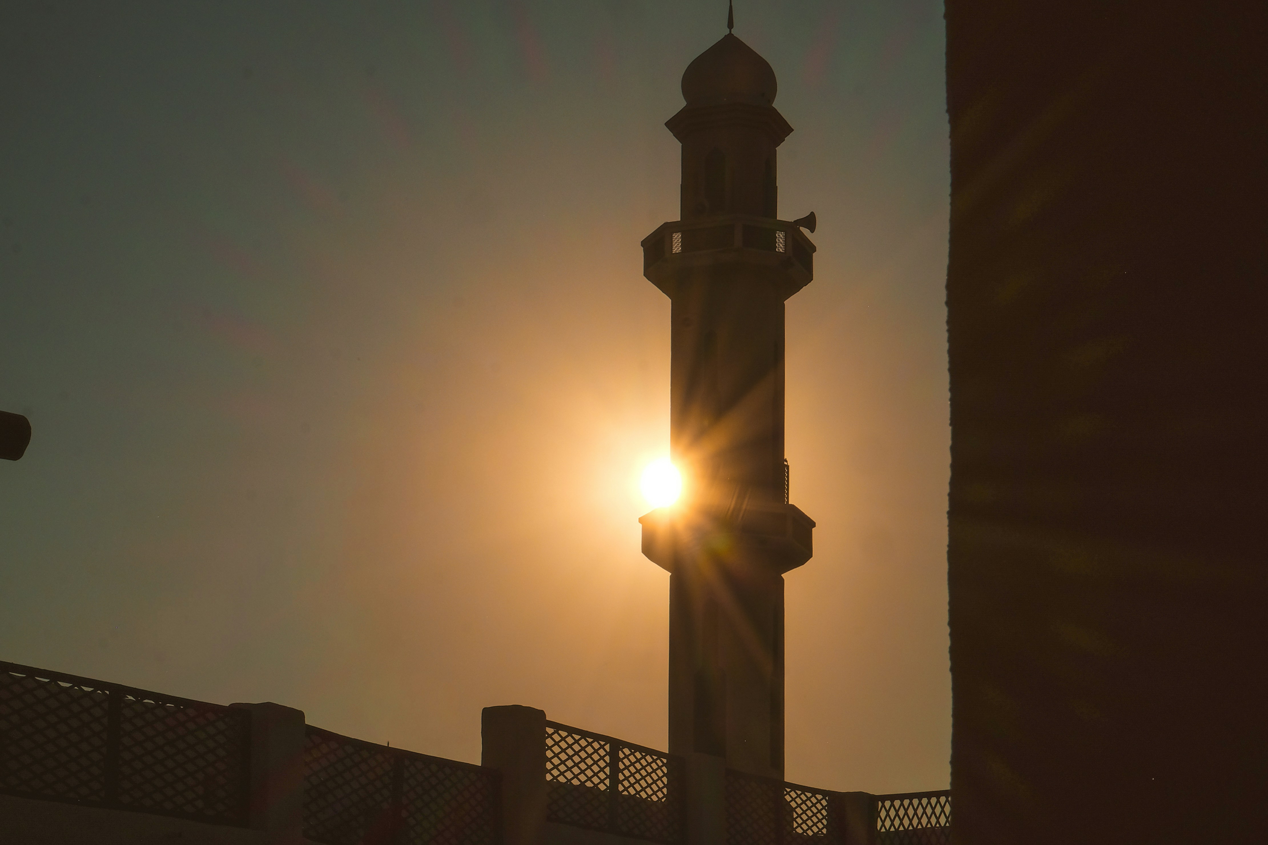 Sunlit Minaret: A Silhouette at Dusk