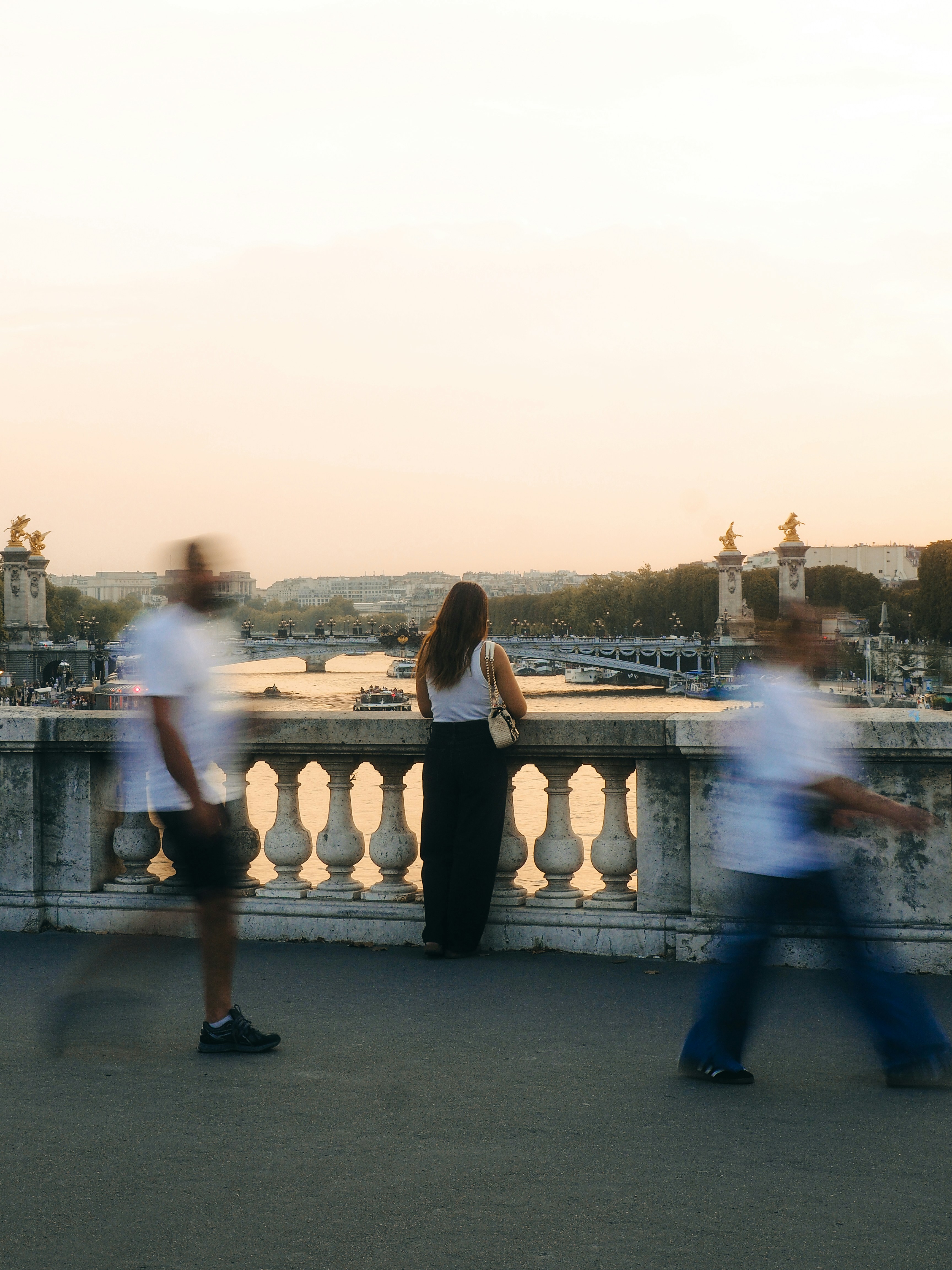 A woman standing by the Seine turns Paris into a soft, poetic daydream. Her silhouette, the river reflections, the calm evening light and the romantic bridges create a blend of Paris lifestyle, travel photography, urban serenity and cinematic solitude. This scene feels intimate, elegant and deeply Parisian—perfect for themes like mindfulness, slow living, wanderlust, feminine perspective and soulful city moments. It captures timeless Paris charm through stillness, emotion and riverfront beauty that invites reflection and storytelling.